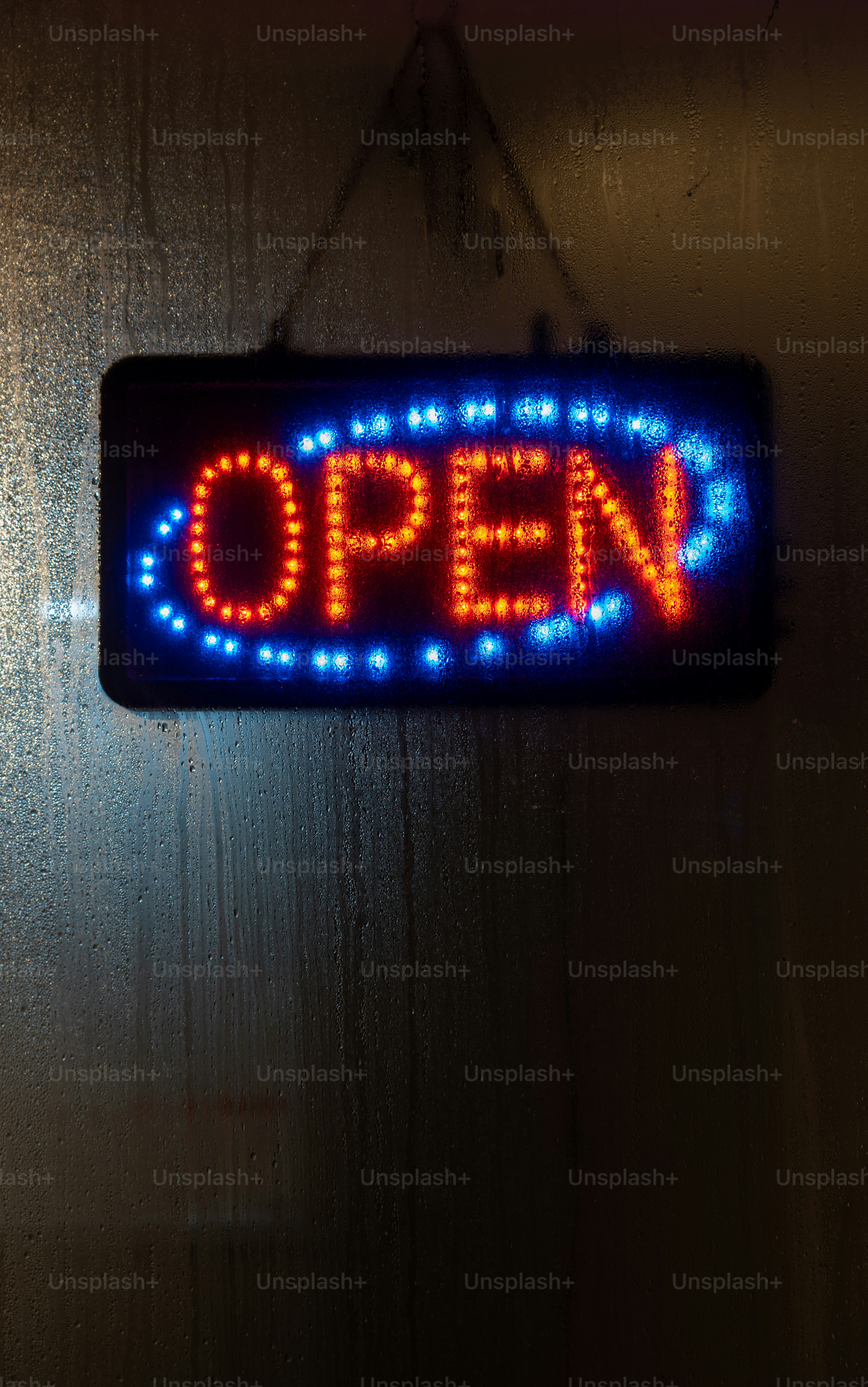 A sign that says open hanging on a wall photo – Kendal Image on Unsplash