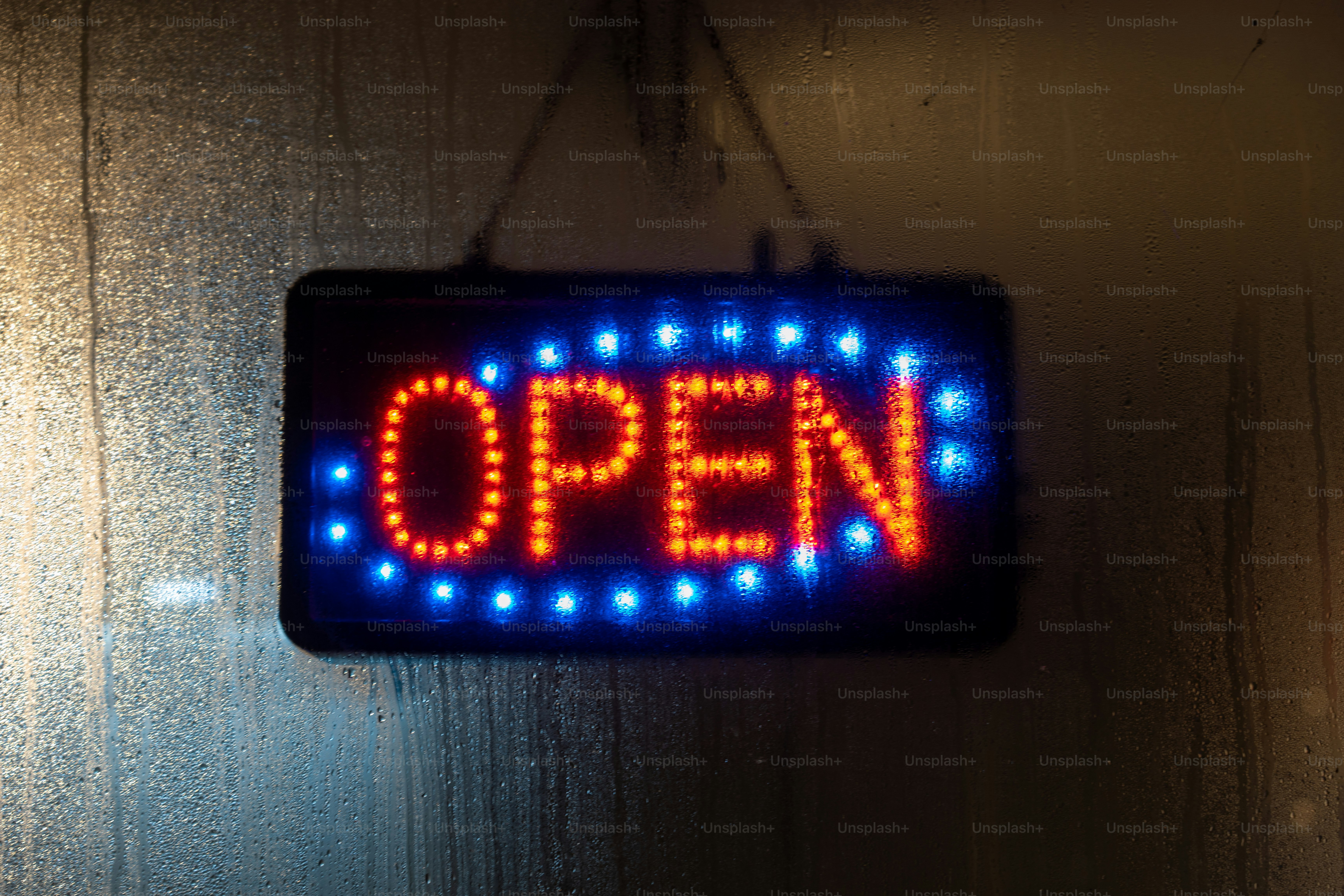 A sign that says open hanging on a wall photo – Kendal Image on Unsplash