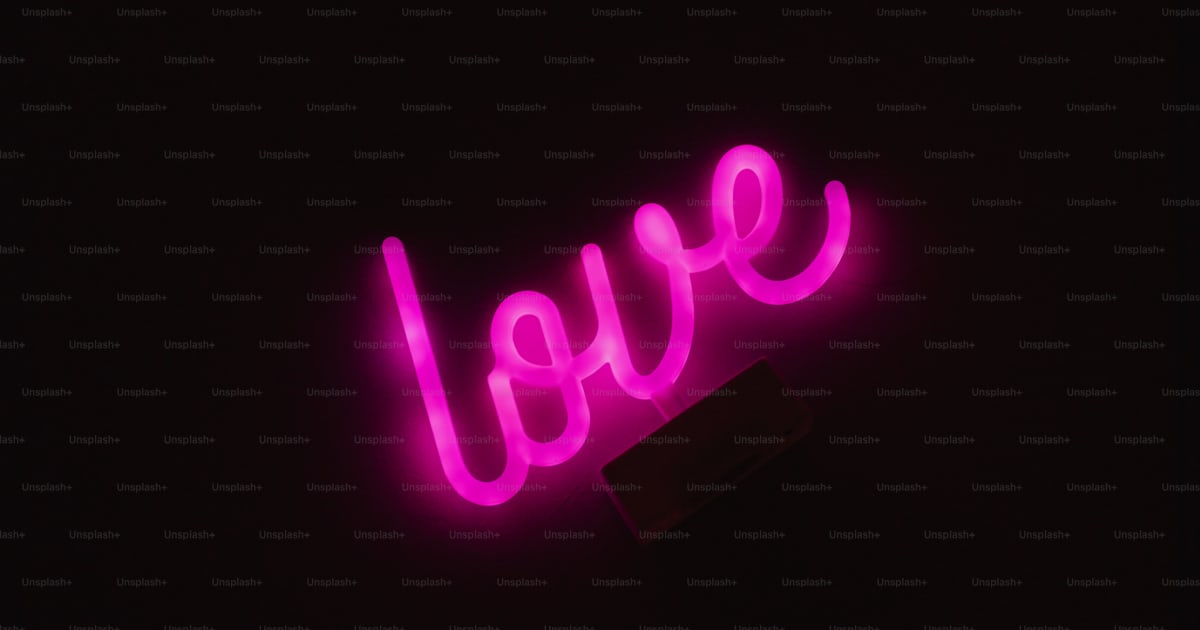 A Neon Sign That Says Love In The Dark Photo Hot Love Image On Unsplash