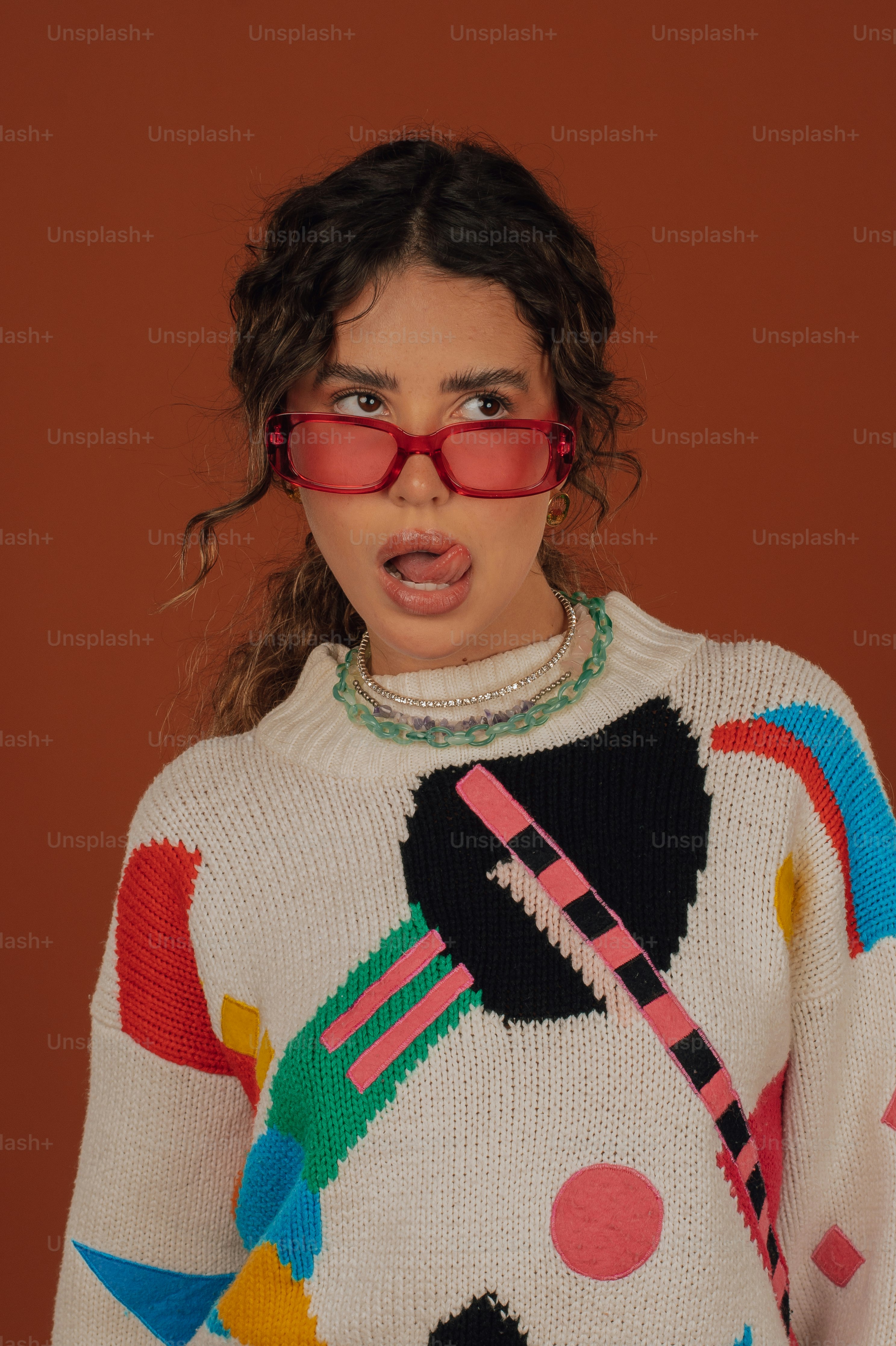A woman in a colorful sweater making a surprised face photo – Jumper ...