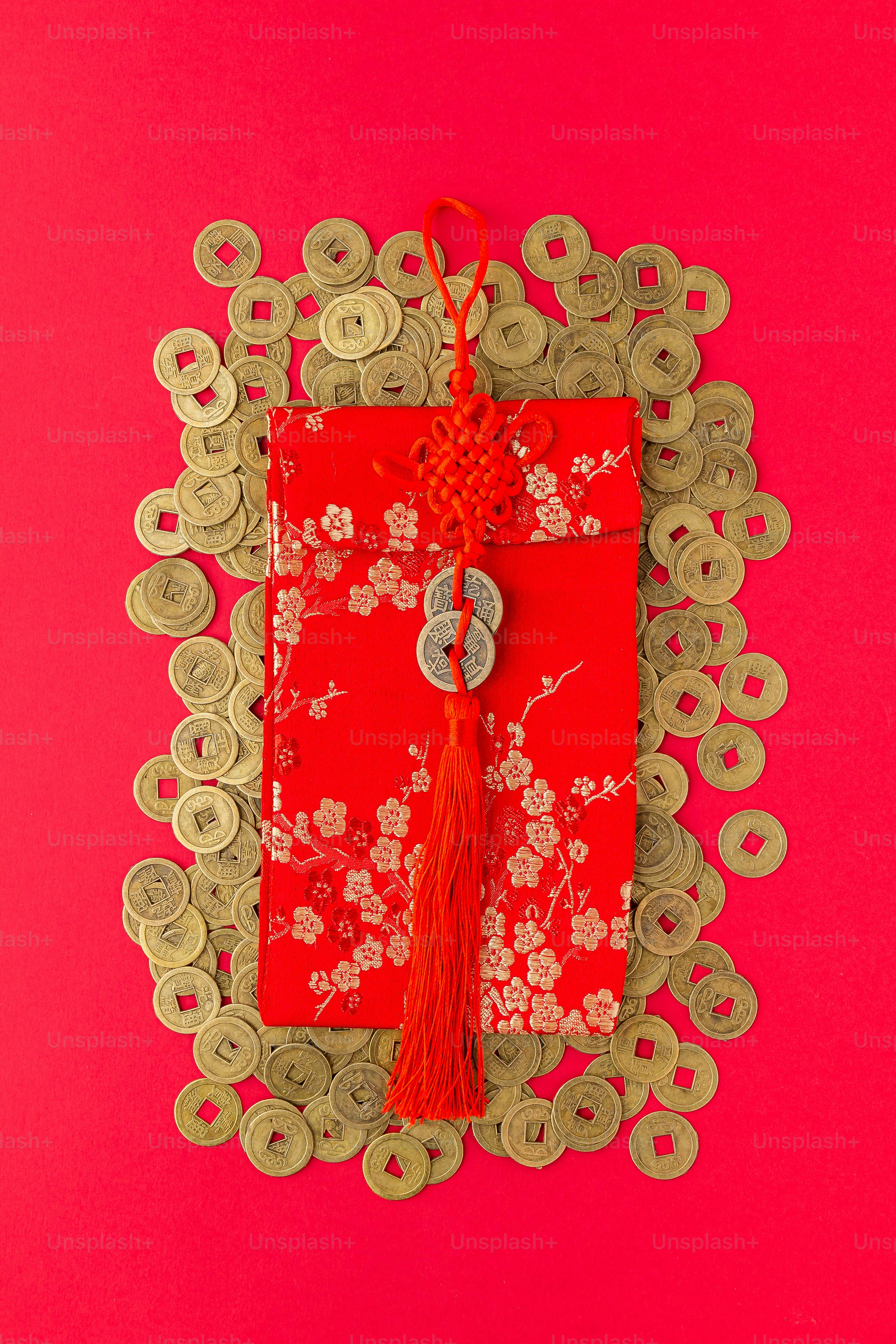 A red envelope with a red tassel on a pink background photo – Feng shui ...