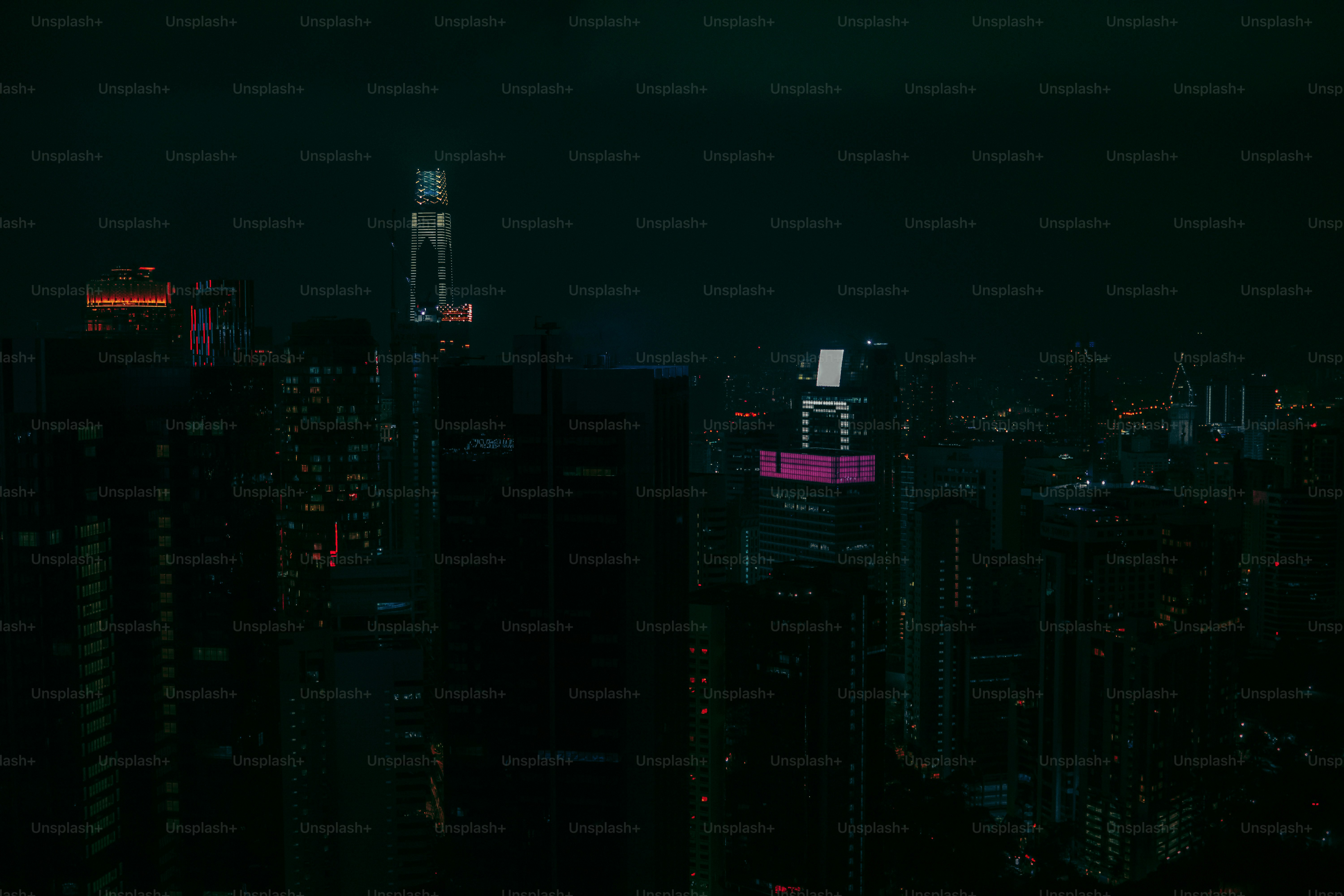 A view of a city at night from the top of a building photo – City Image ...