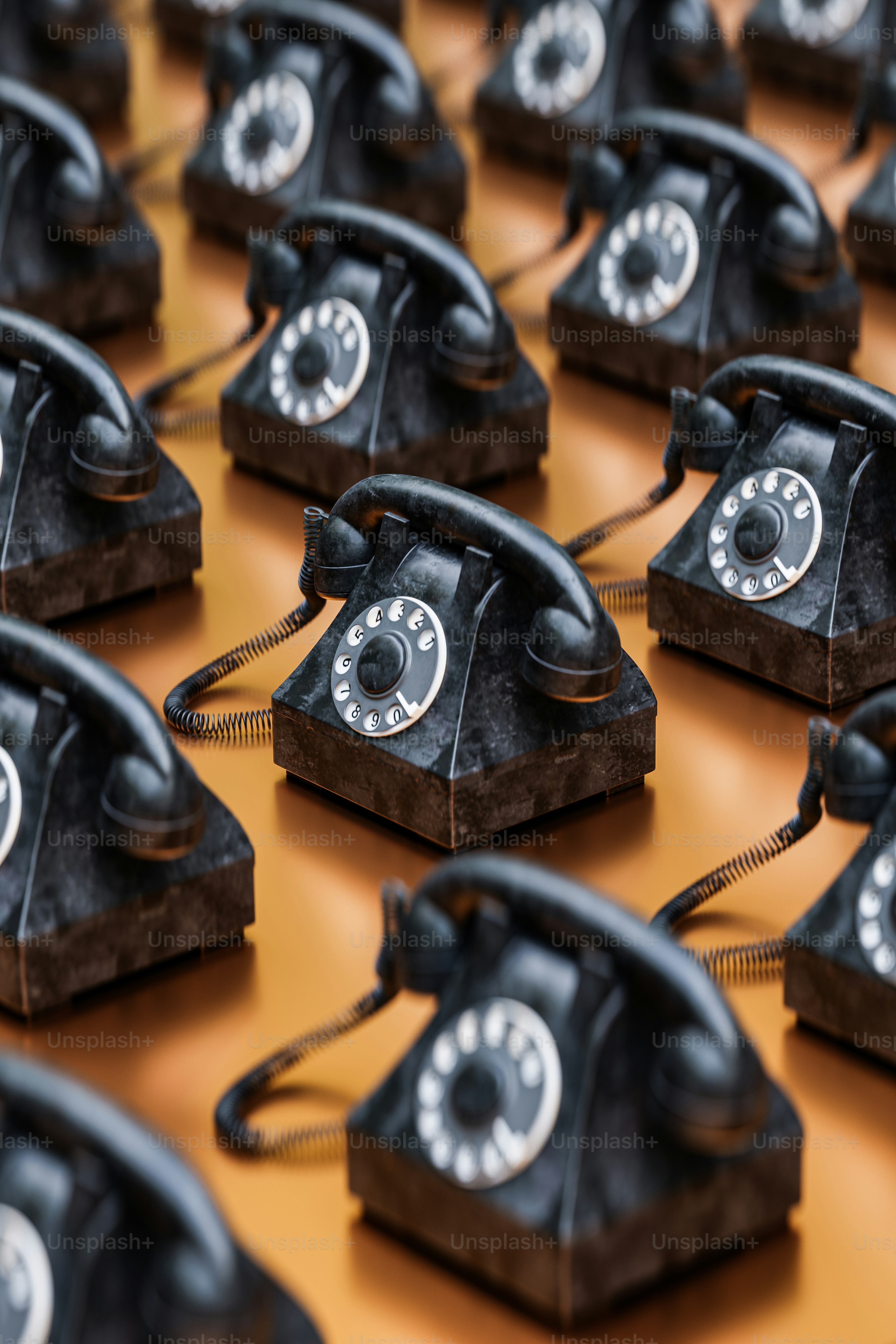 A group of old fashioned telephones sitting on top of a table photo ...