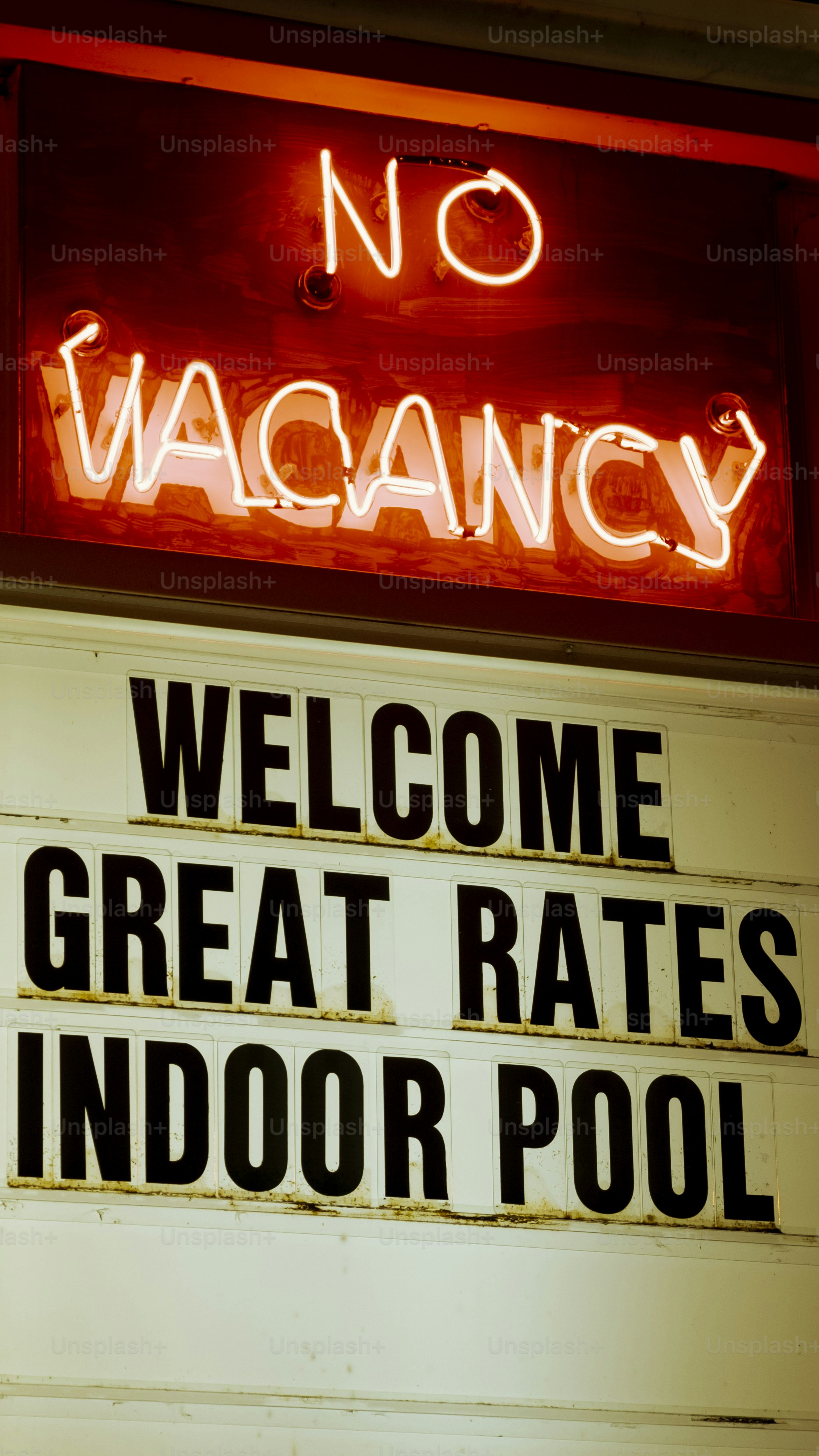 A neon sign that says no vacancy welcome great rate indoor pool photo ...