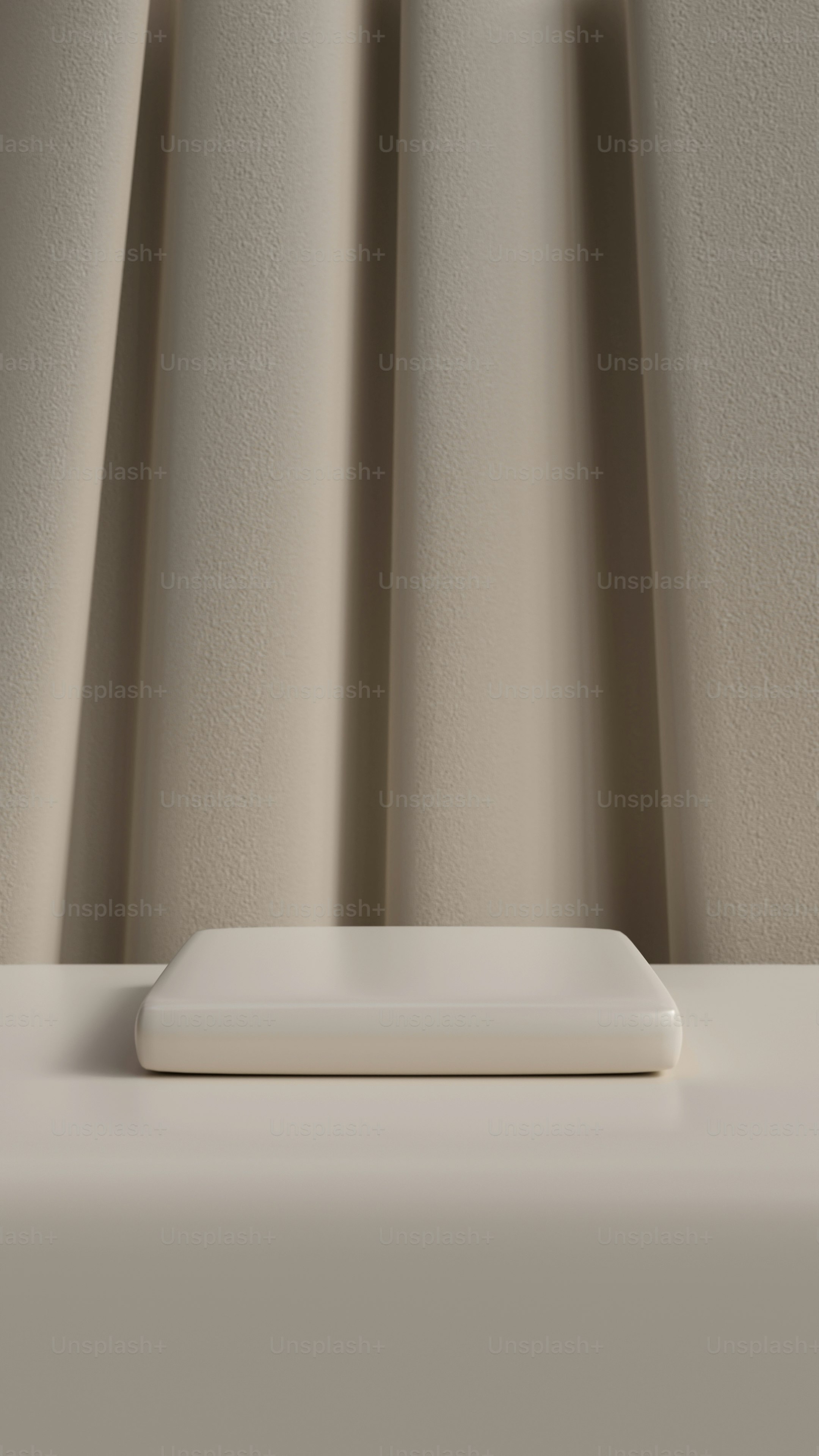 A white square object sitting on top of a table photo – Abstract Image ...