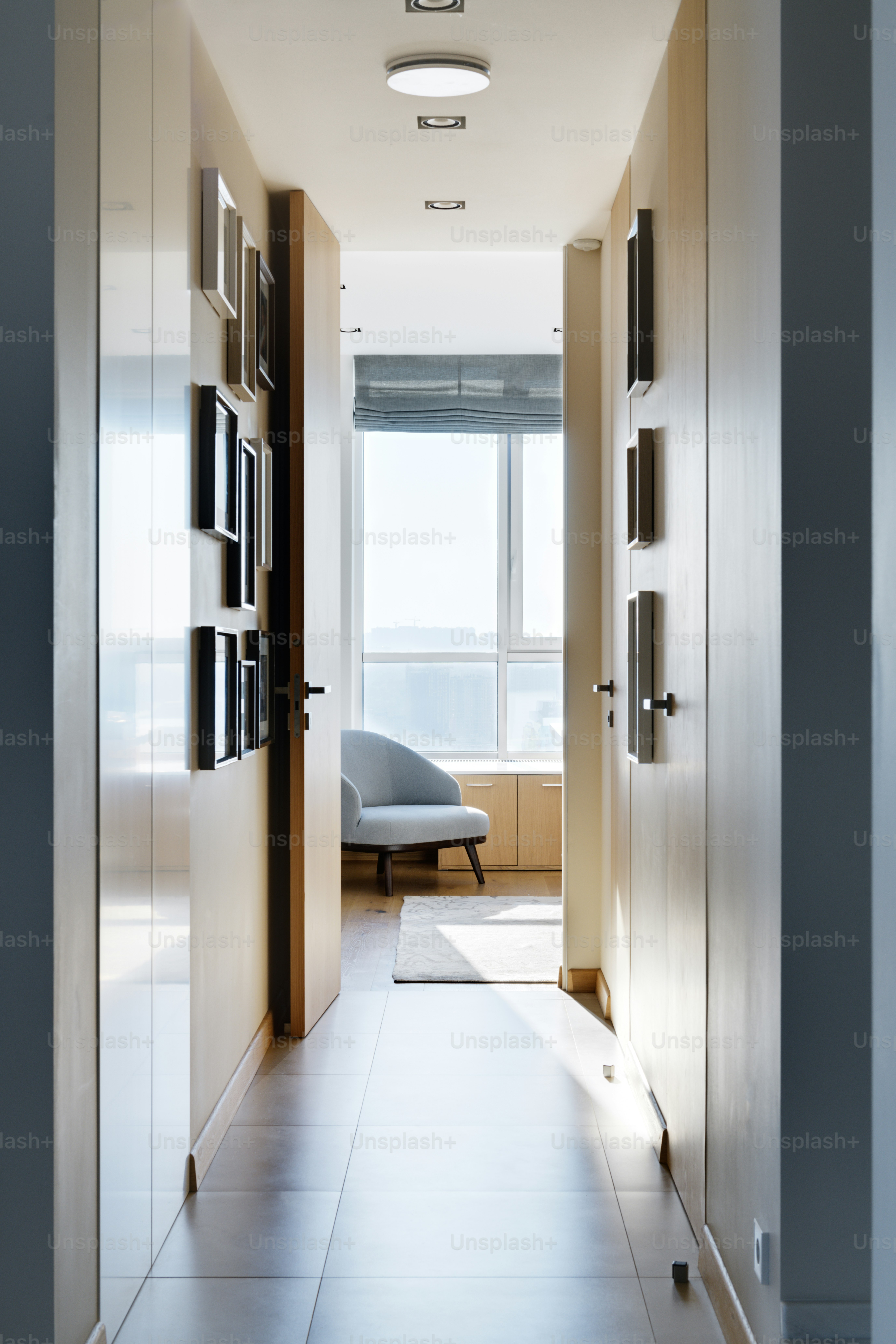 A hallway leading to a living room and bedroom photo – Flooring Image ...