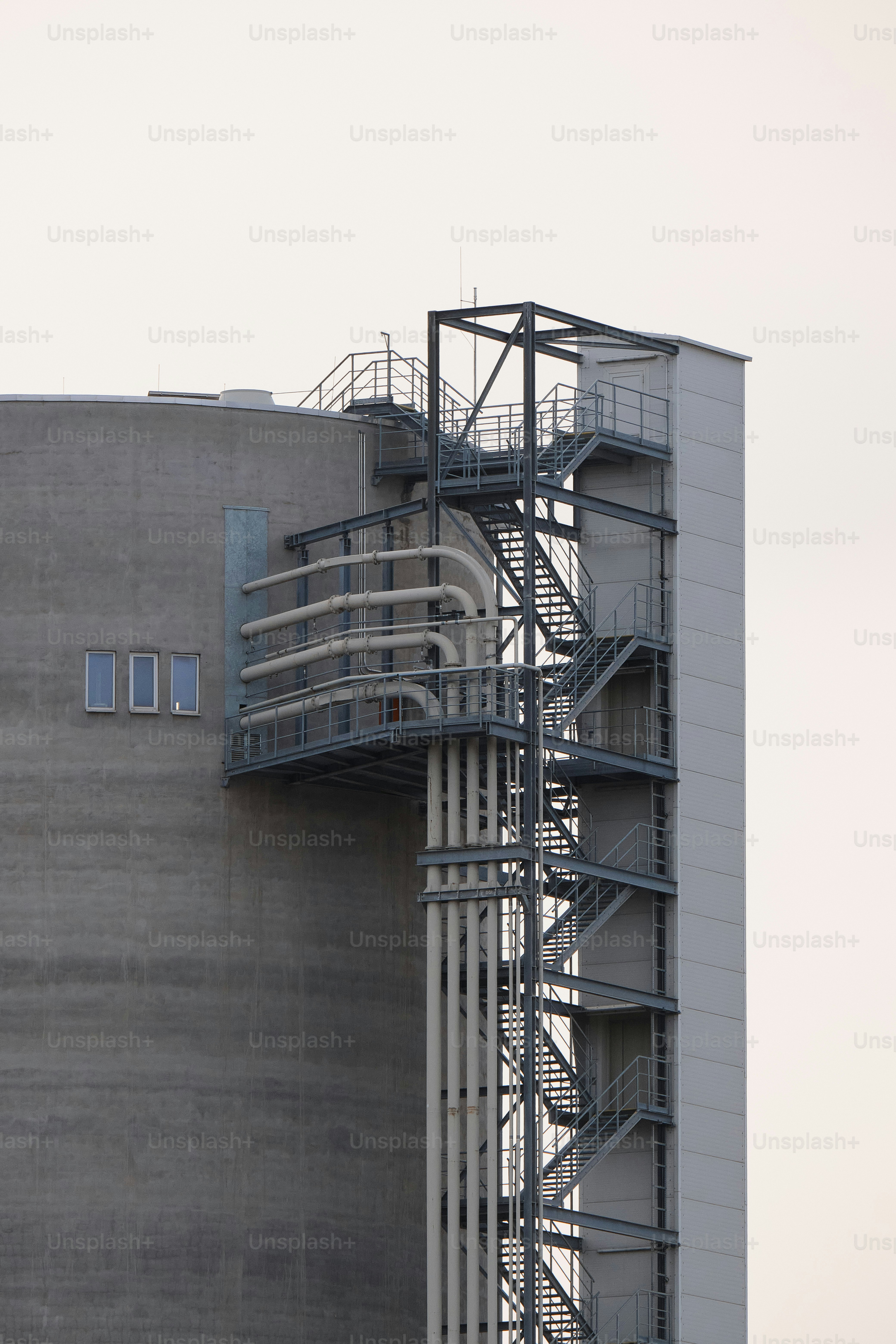 A large industrial building with a lot of pipes photo – Factories Image ...