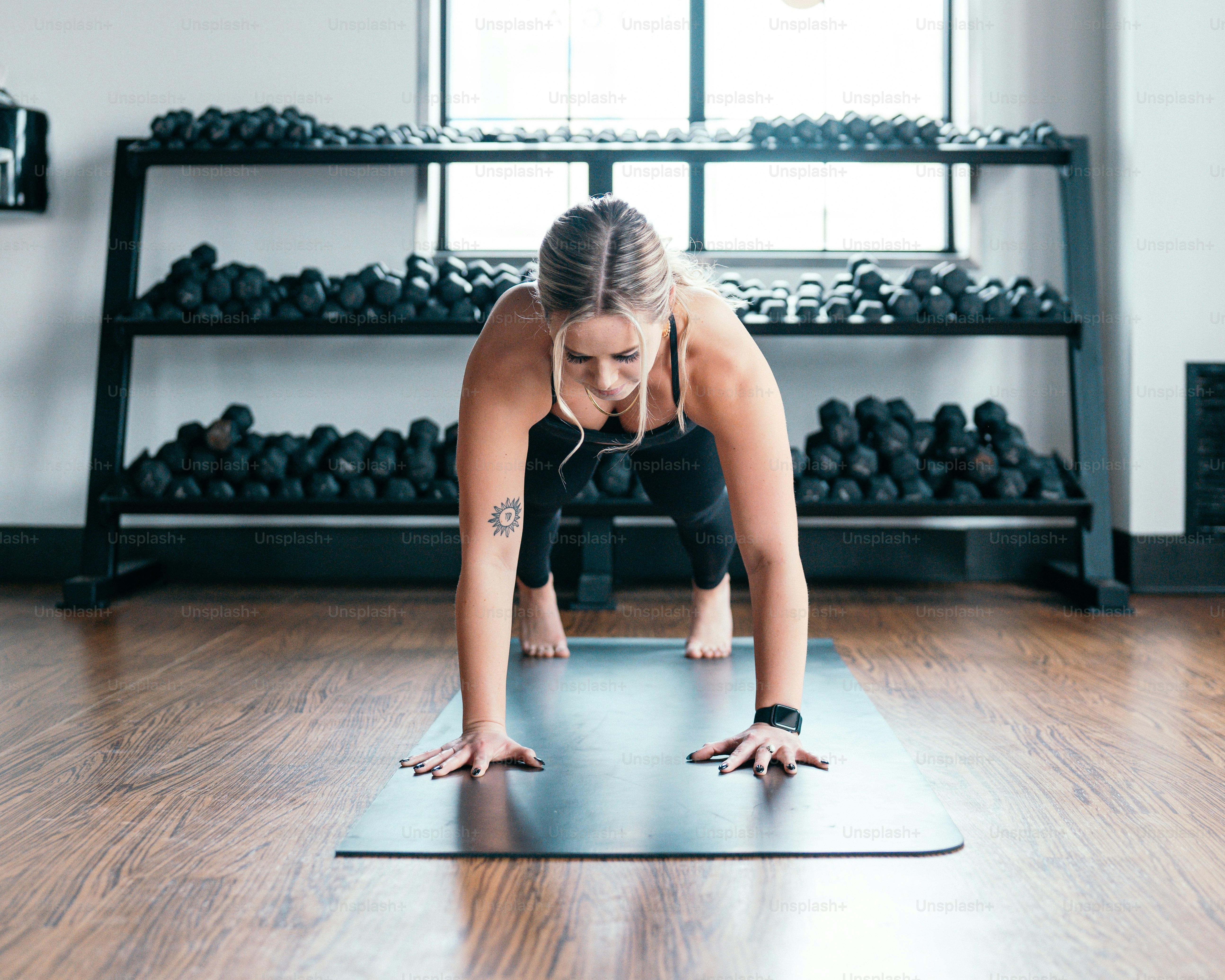 A woman doing push ups on a mat in a gym photo – Exercise Image on Unsplash