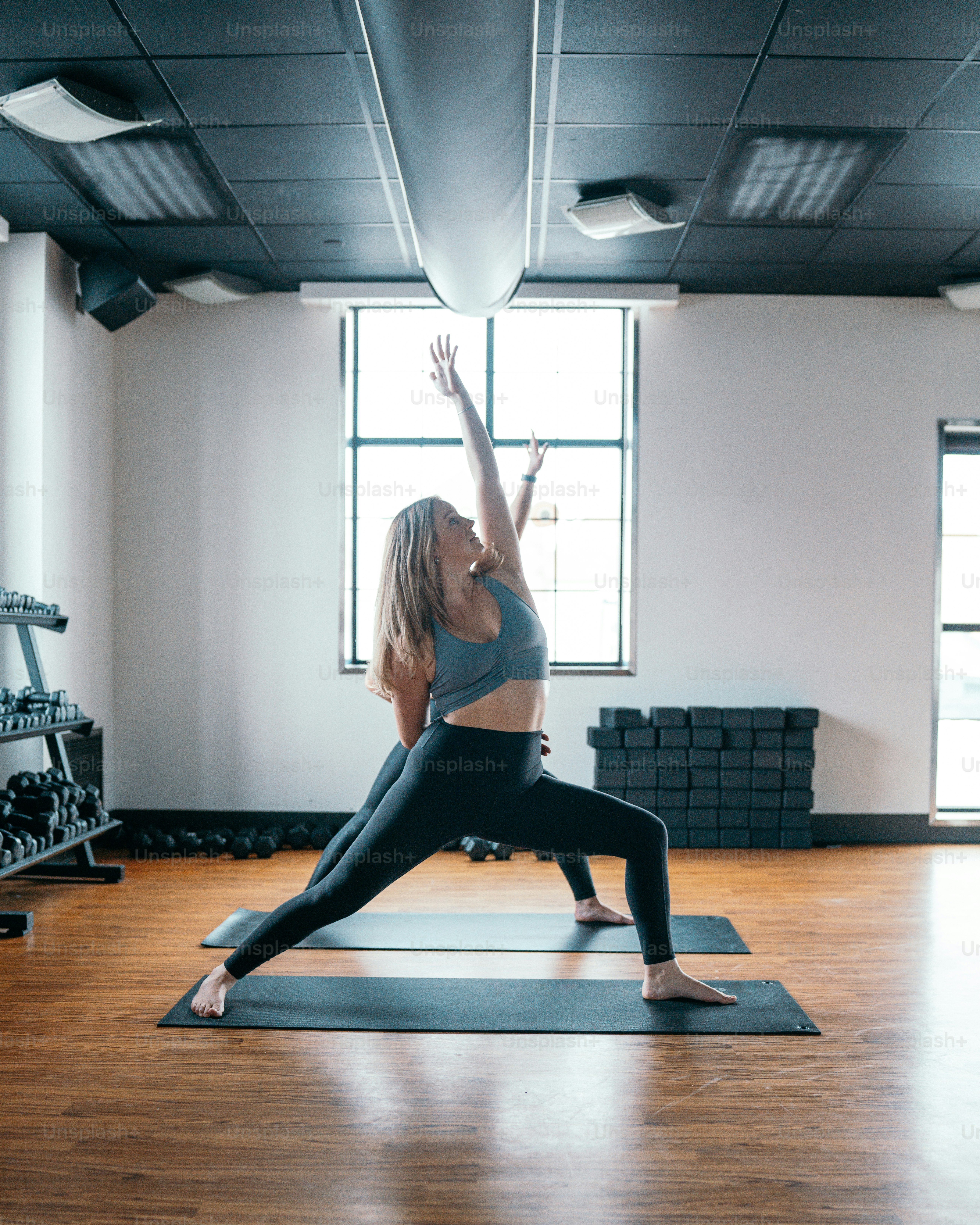A woman is doing yoga in a gym photo – Yoga Image on Unsplash