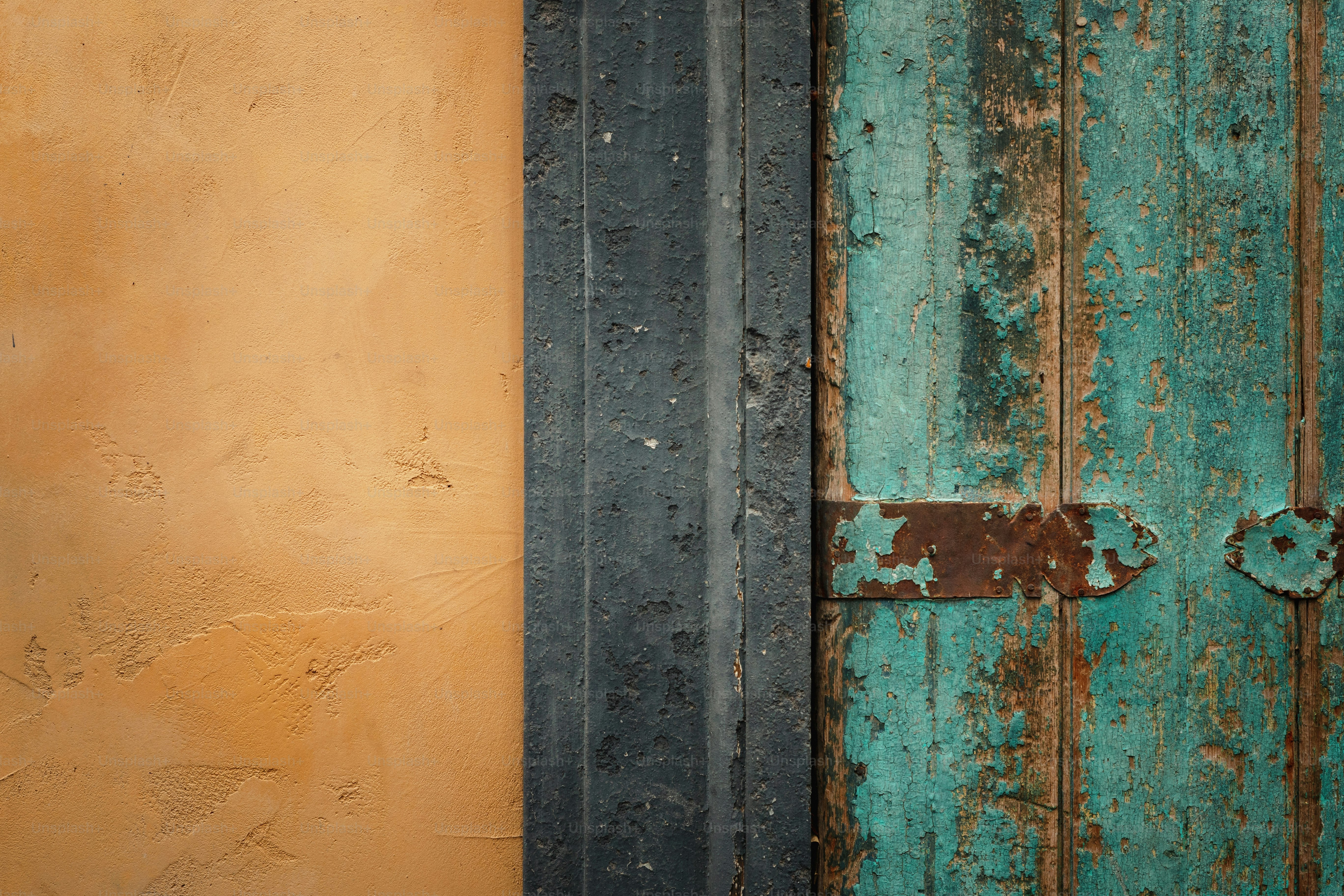 A close up of a rusted metal door photo – Teal and orange Image on Unsplash