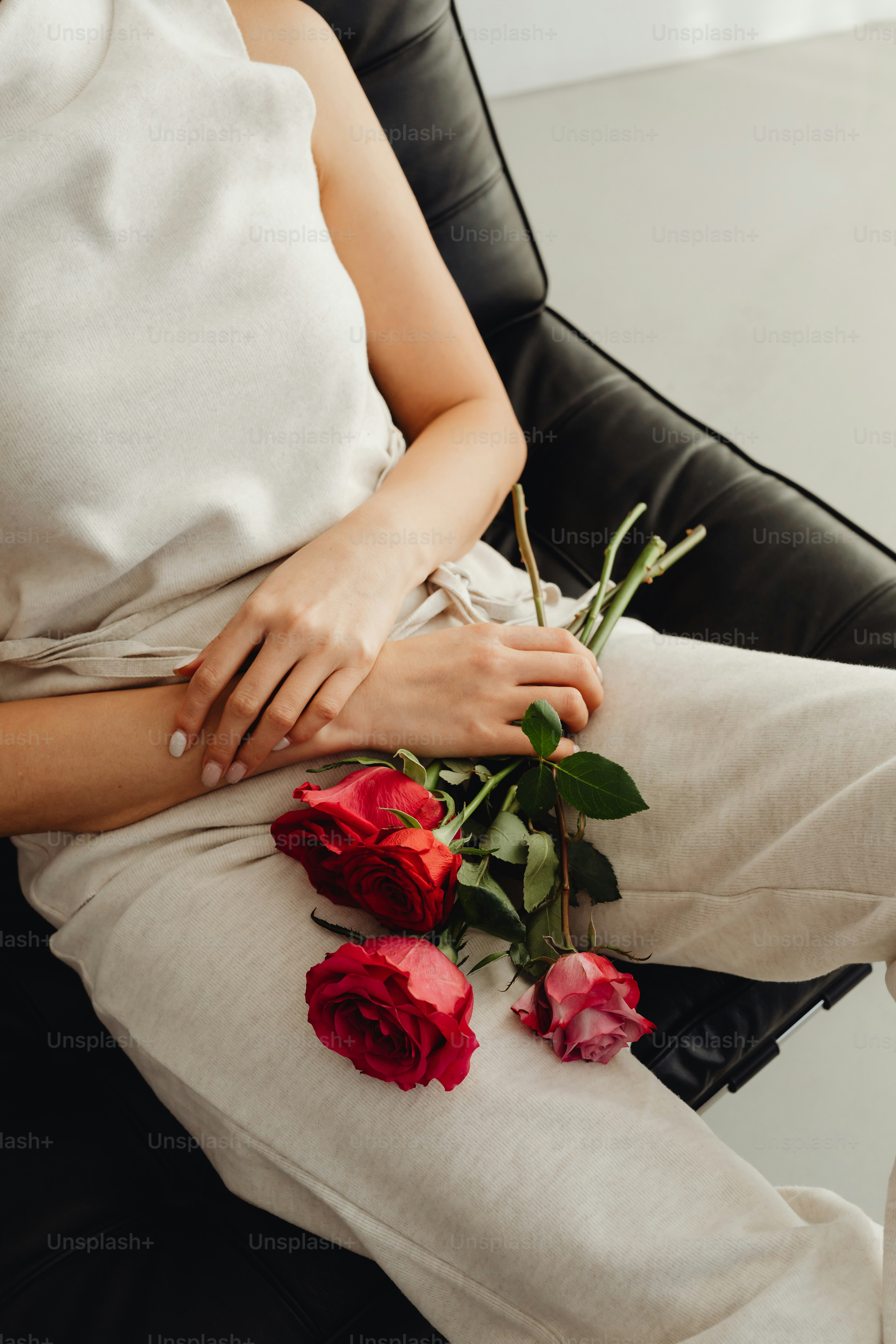 A woman sitting on a chair with a bouquet of roses photo – Flowers ...