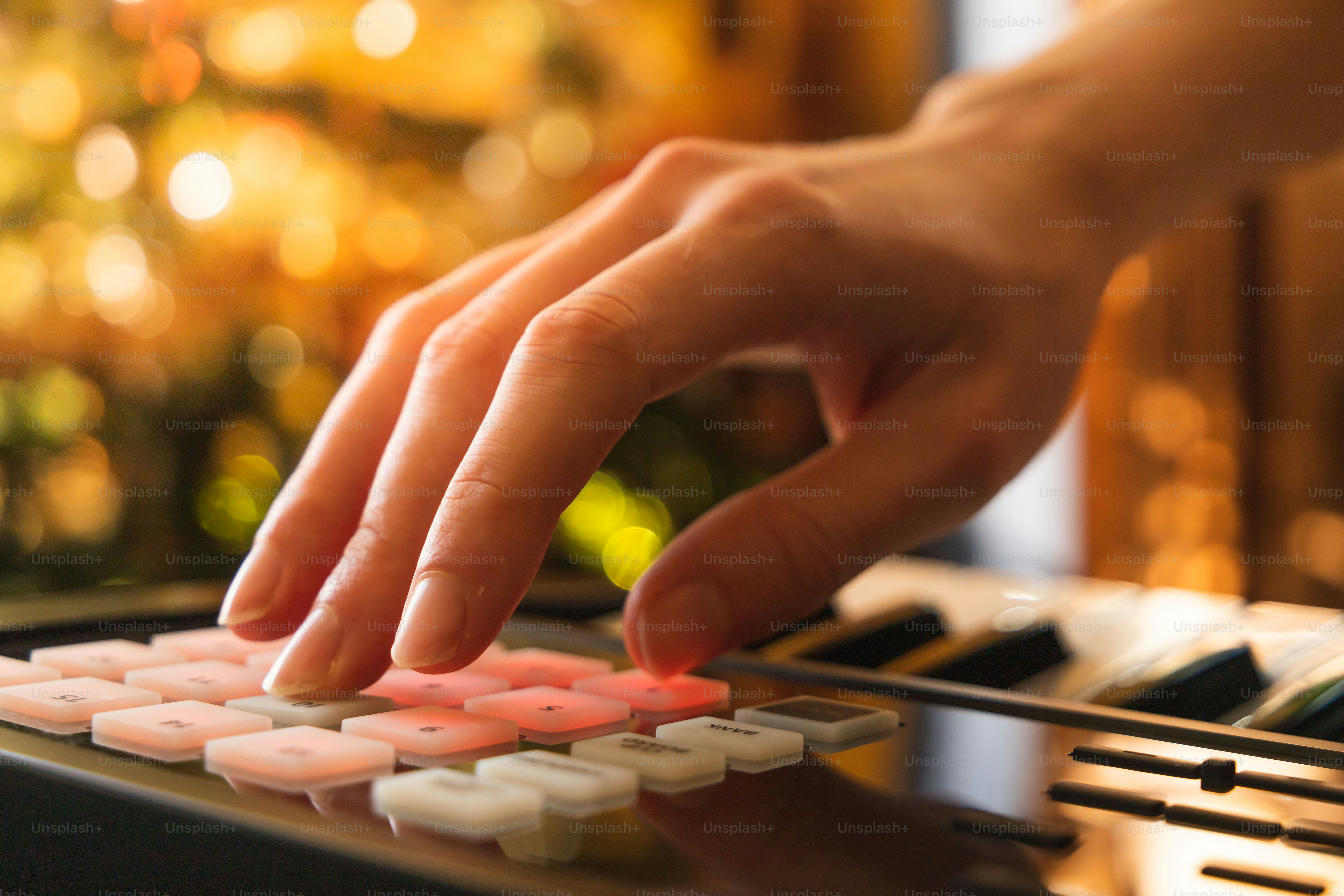 A close up of a person pressing buttons on a keyboard photo – Synth ...