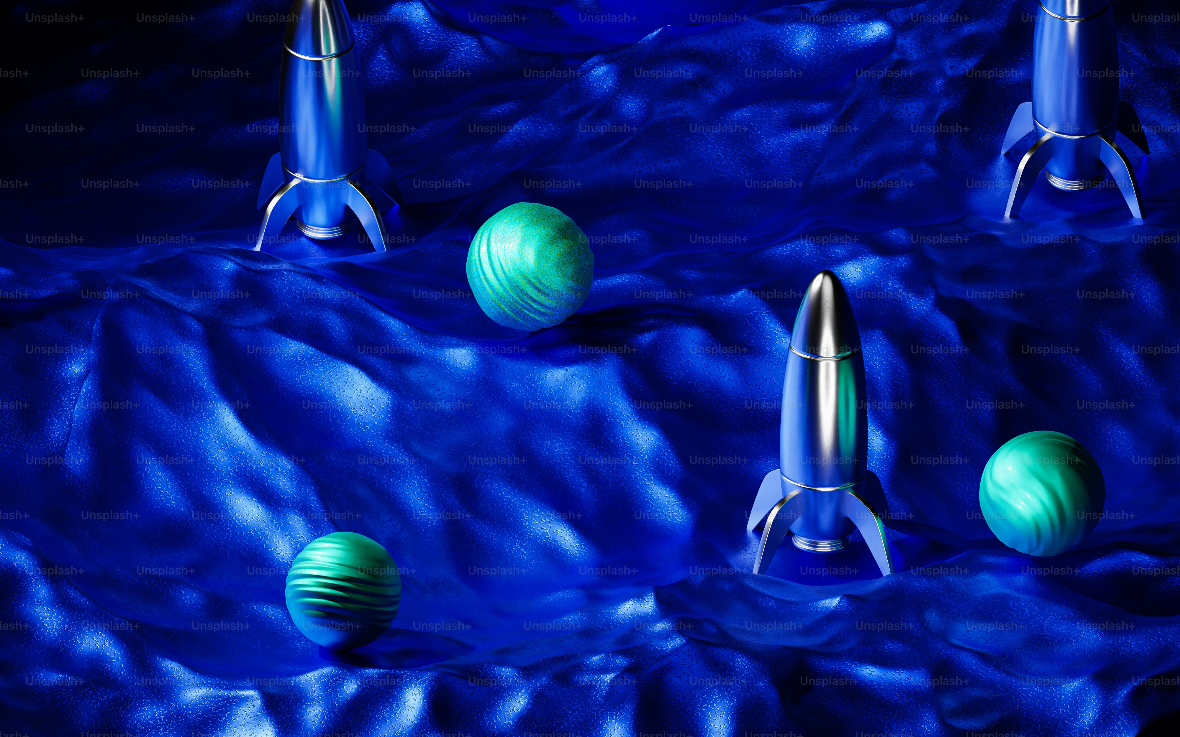A group of blue rockets sitting on top of a blue cloth photo ...