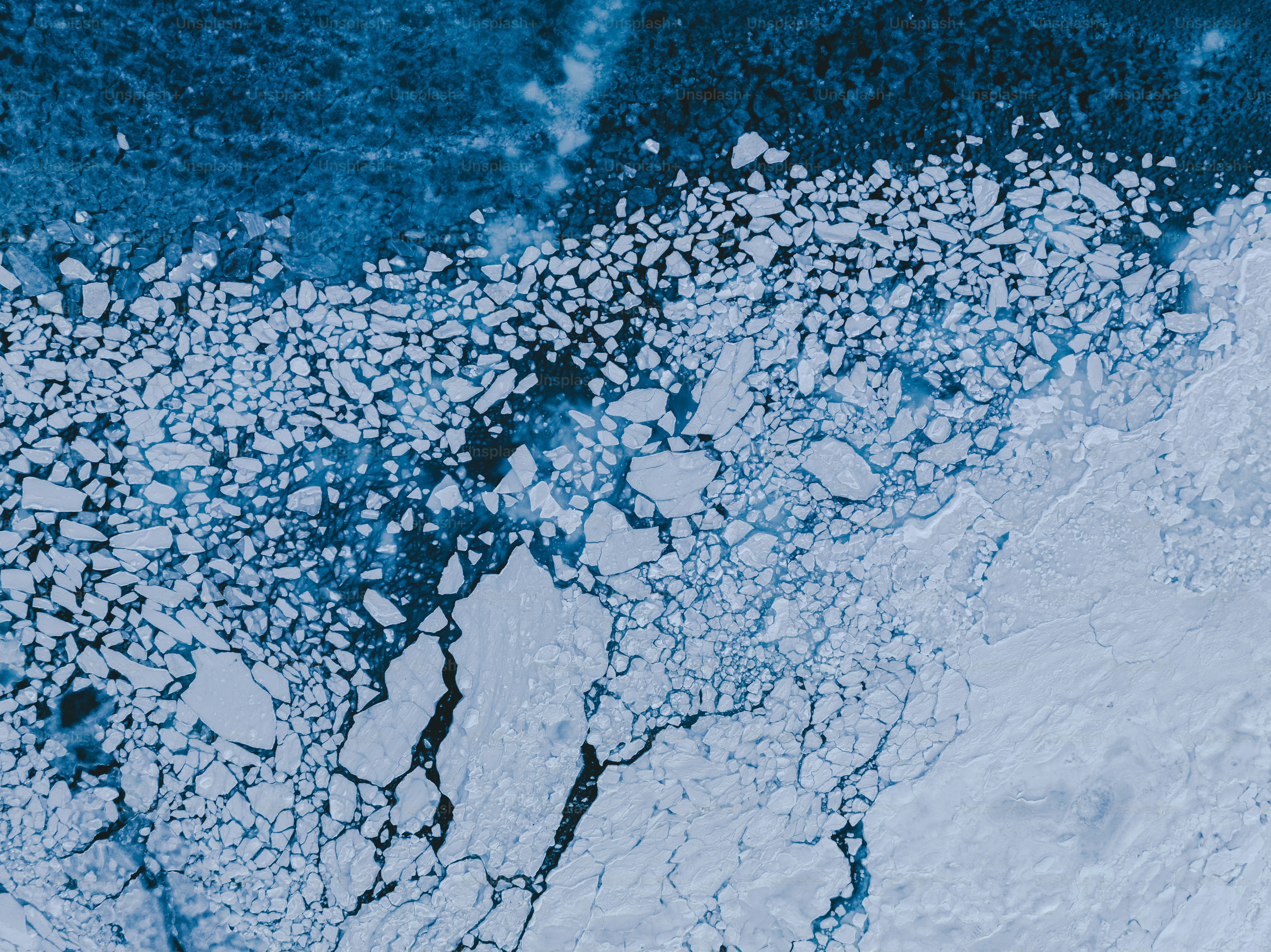 An aerial view of ice floes and water photo – Texture Image on Unsplash