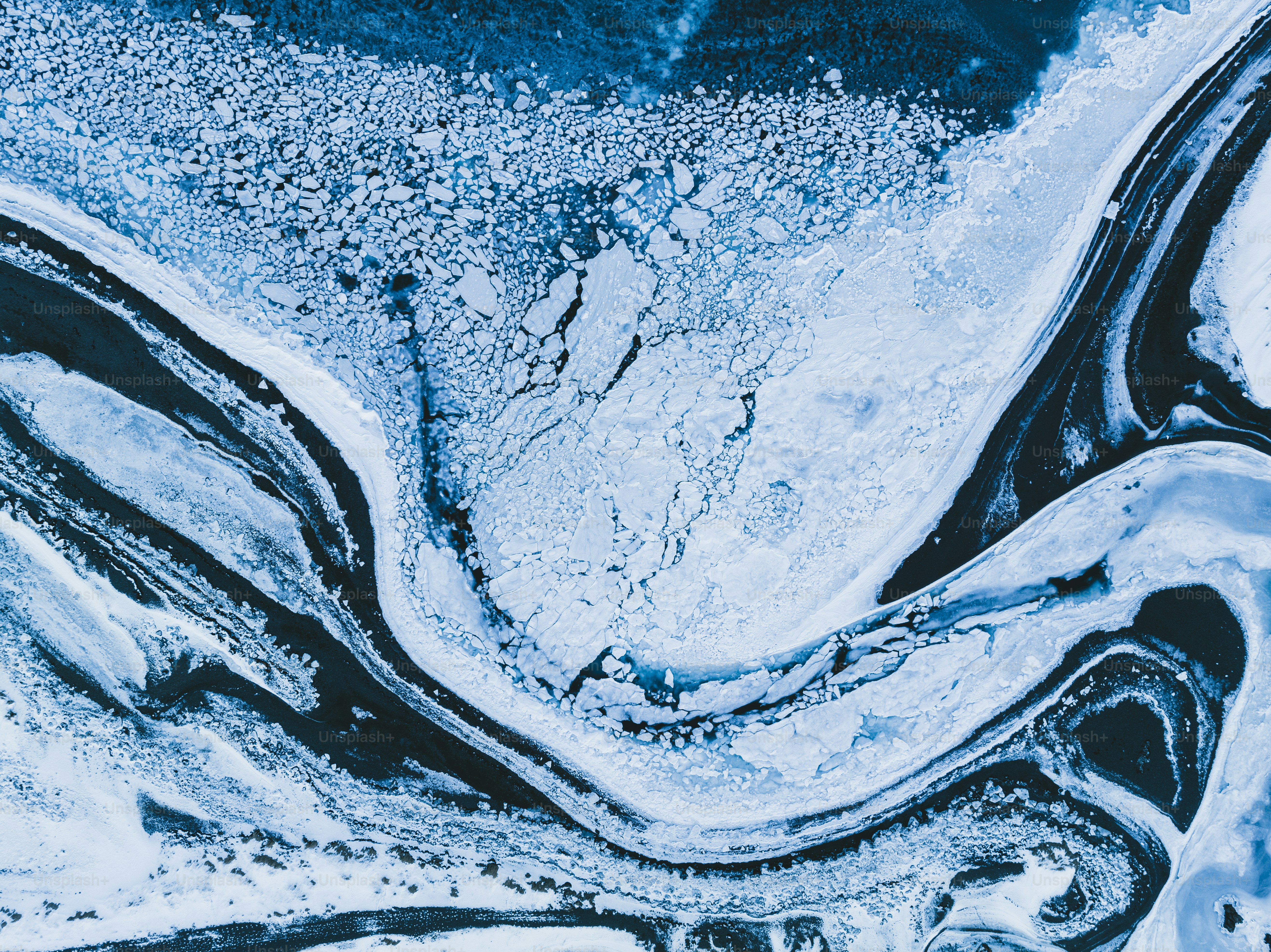 An aerial view of ice and water photo – Floes Image on Unsplash