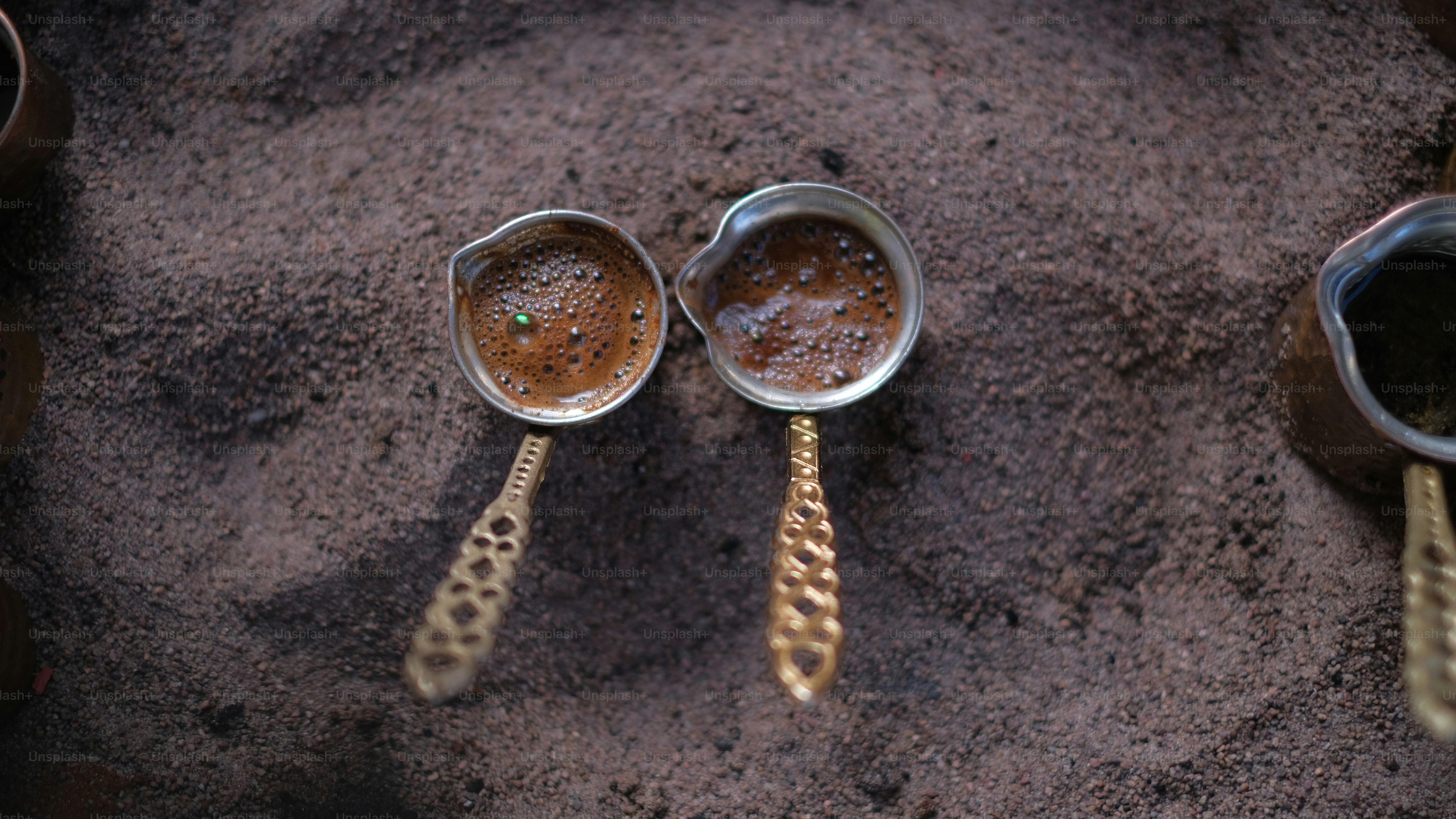 A couple of spoons that are sitting in the sand photo – Full Image on ...