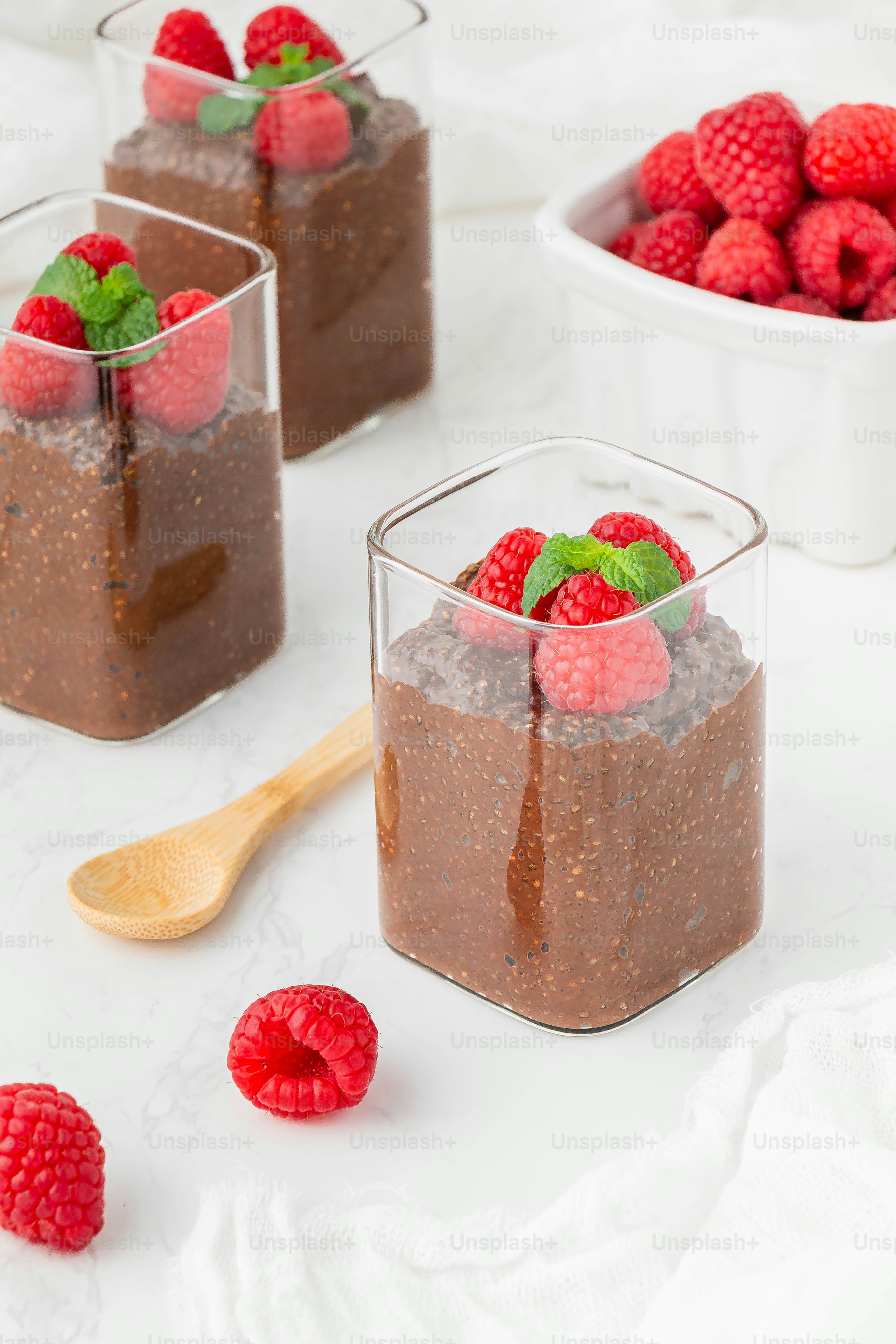 Raspberries and chocolate pudding in small glass containers photo ...