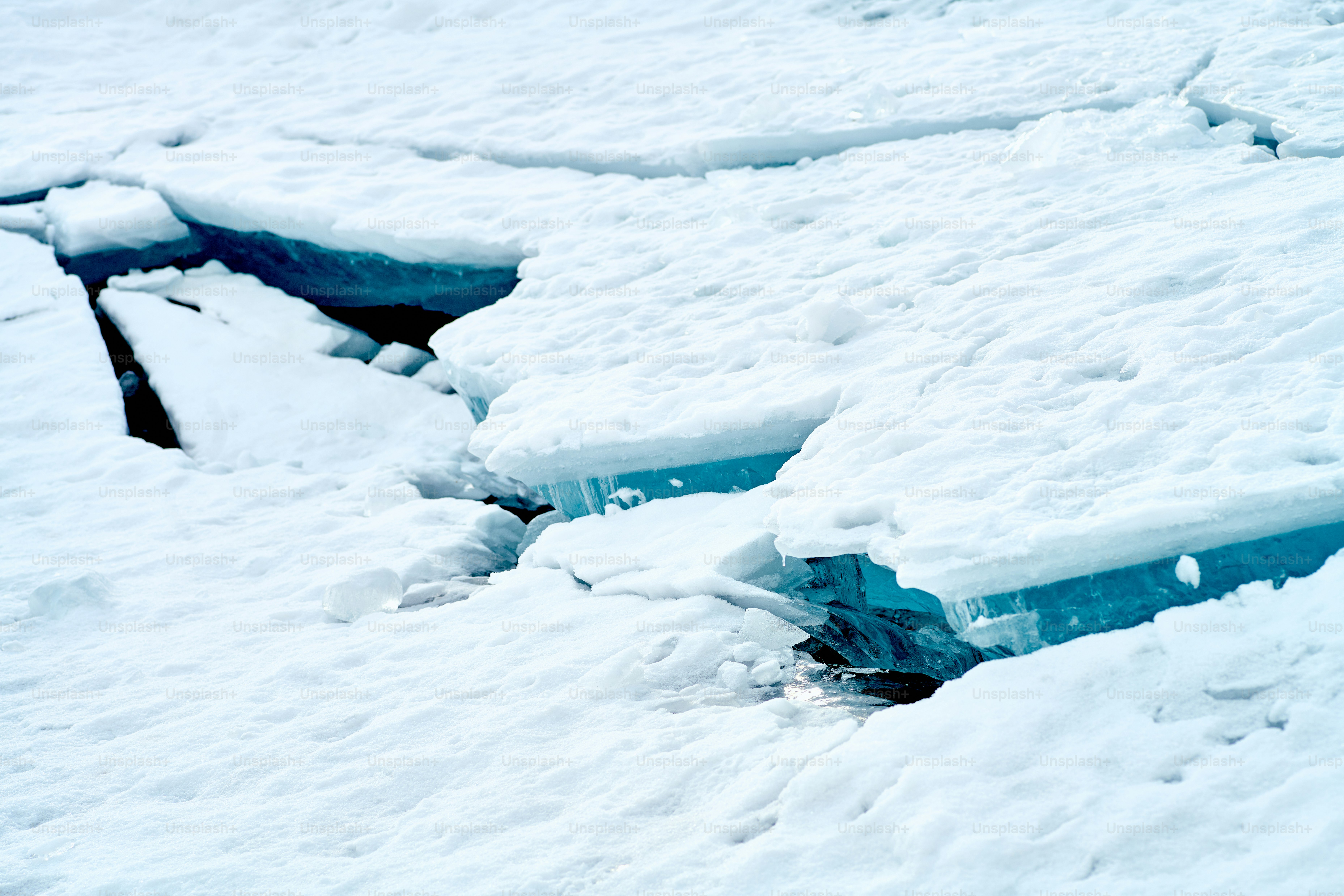 A large crack in the ground covered in snow photo – Nature Image on ...