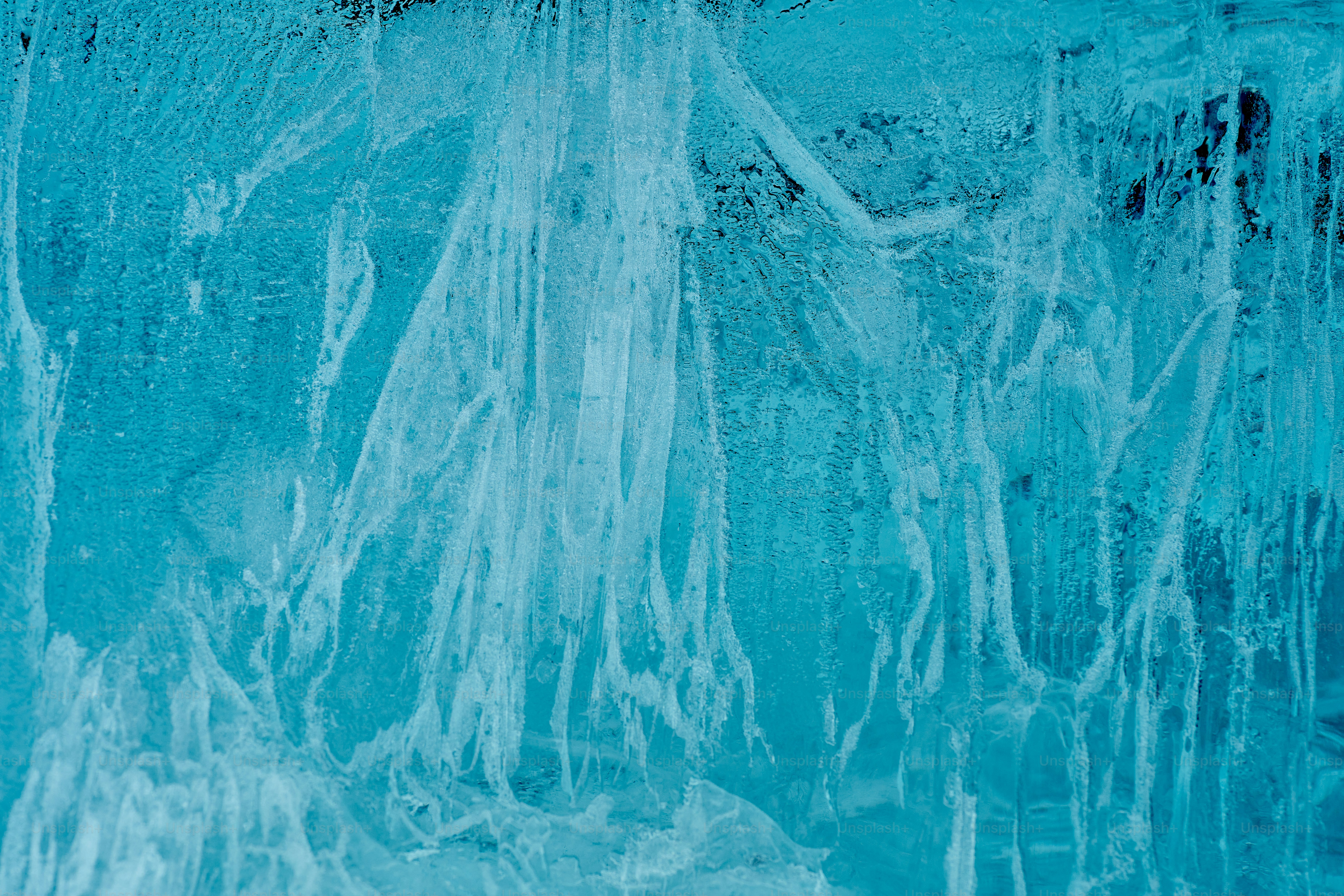 A man standing in front of a blue wall covered in icicles photo ...