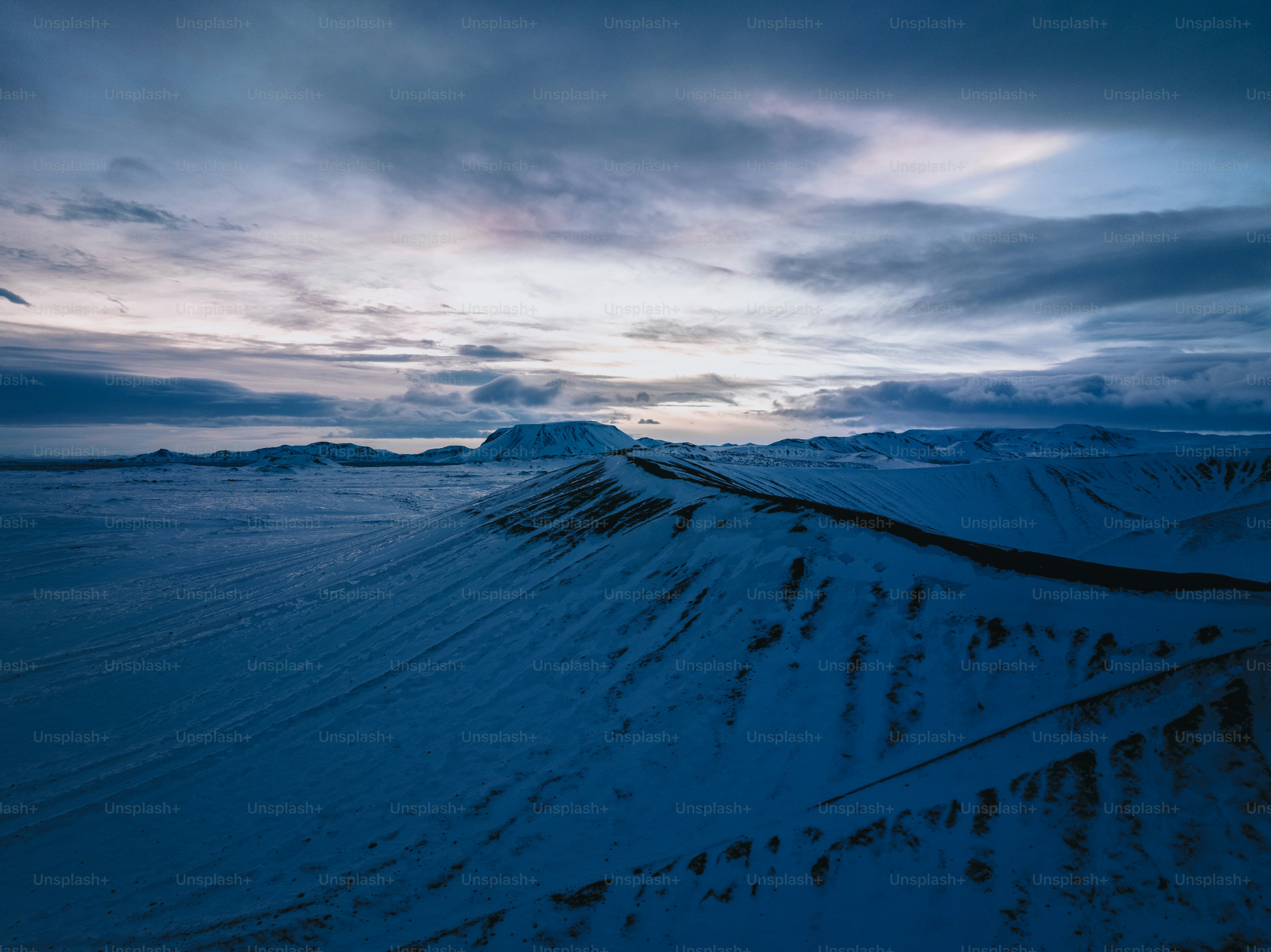 A snowy landscape with a mountain in the distance photo – Landscape ...