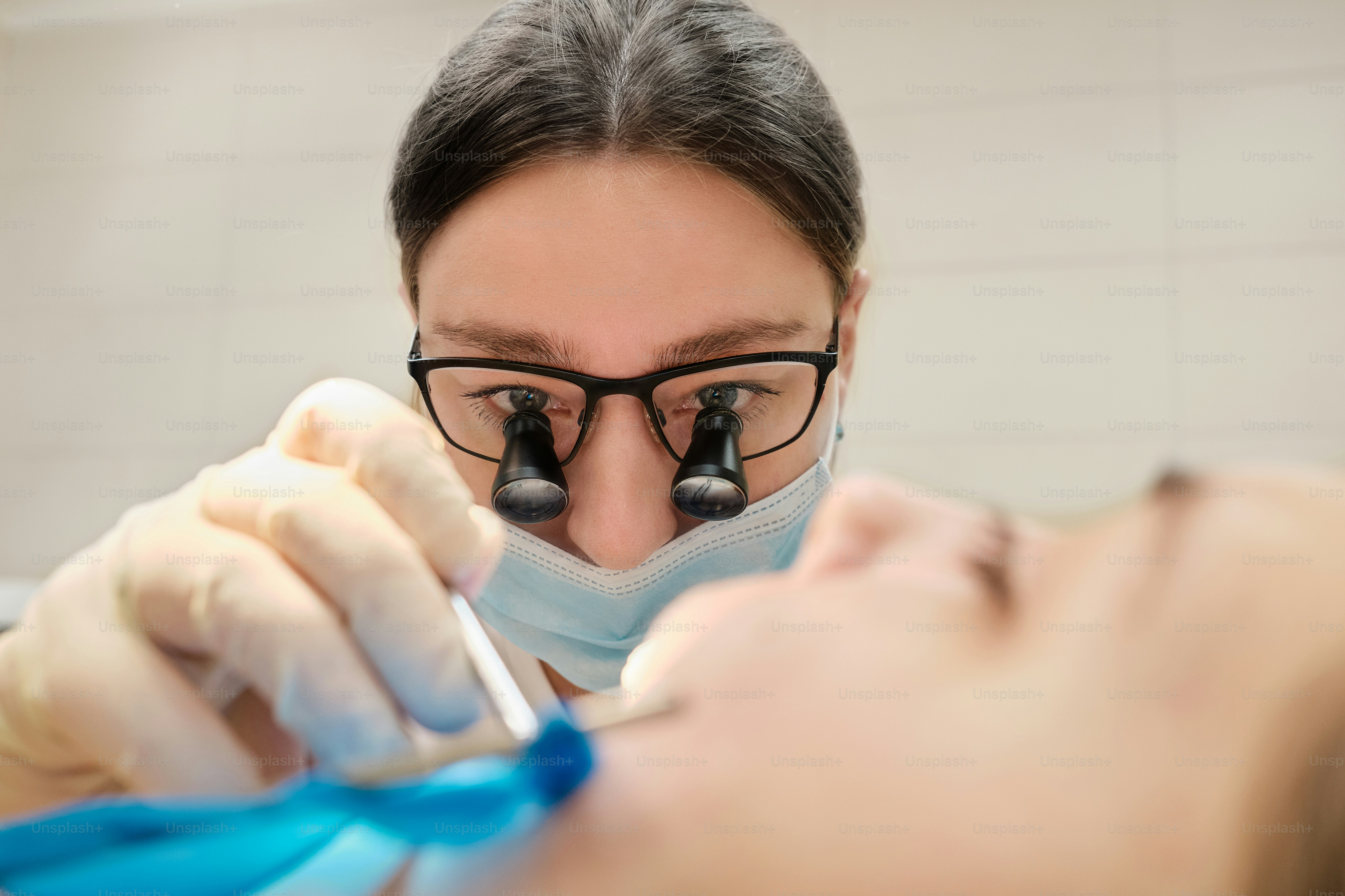 A woman getting her teeth checked by a dentist photo – Professional ...