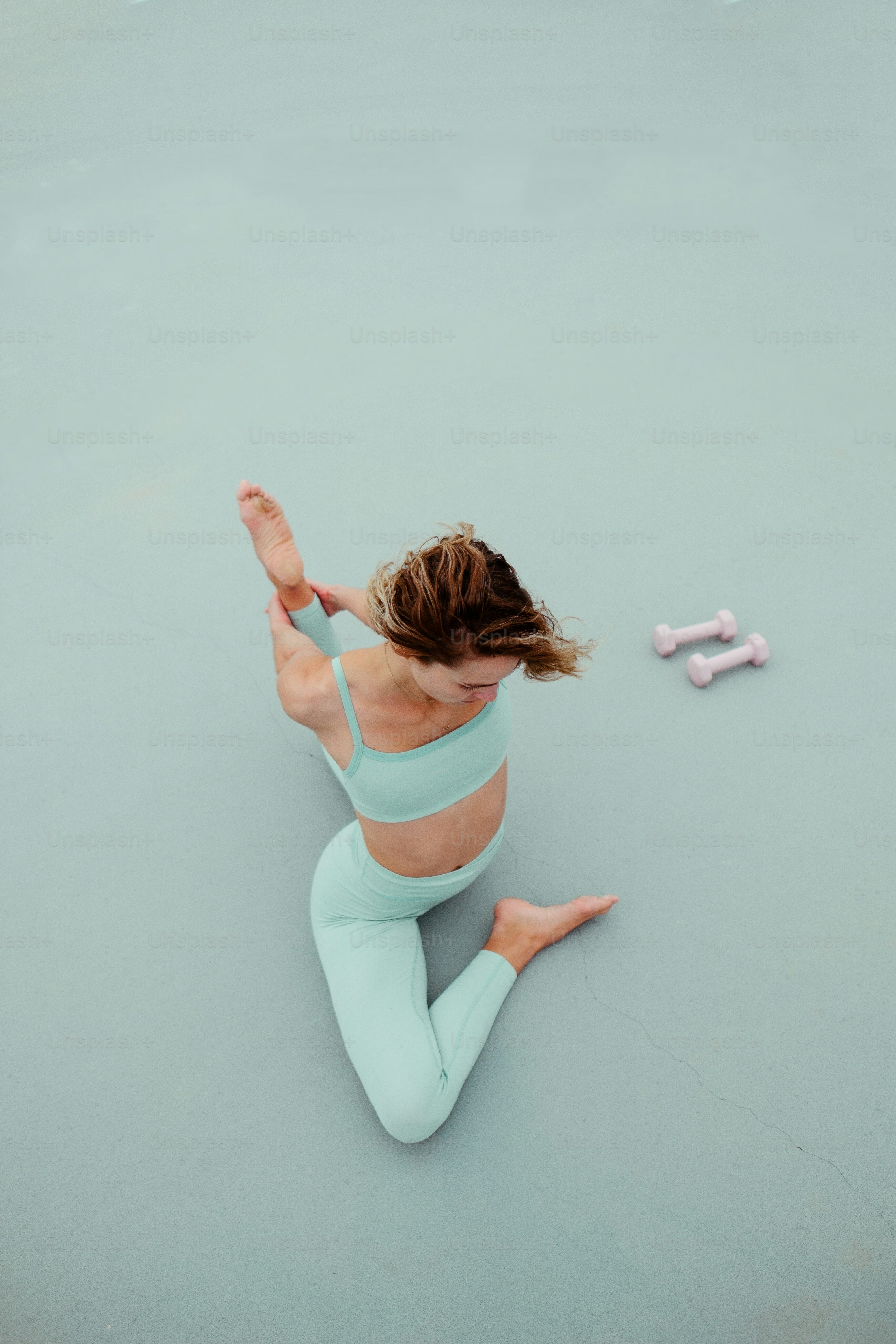 A woman sitting on the ground with a pair of scissors photo – Yoga ...