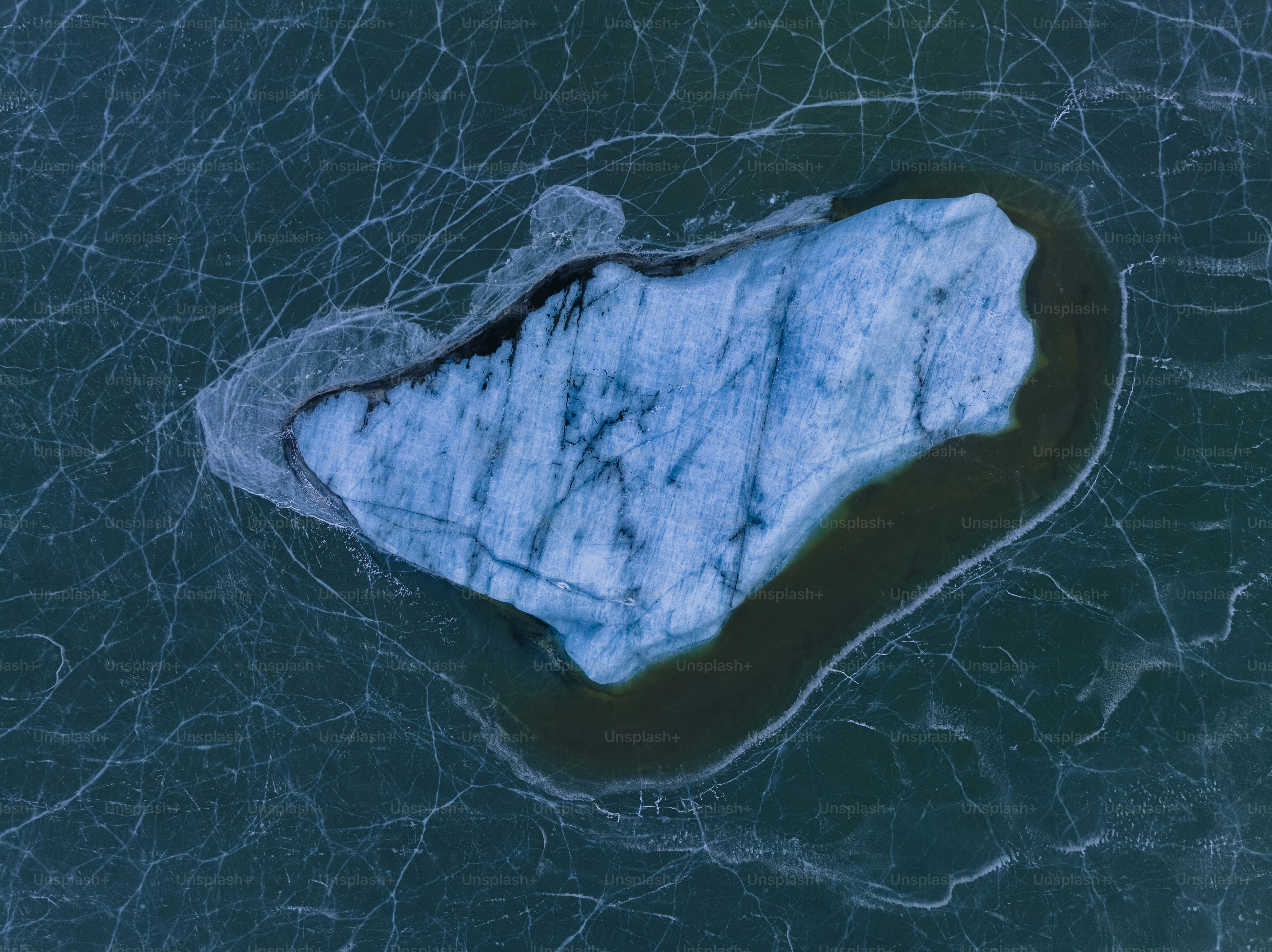 An aerial view of ice floes floating in the water photo – Ice Image on ...