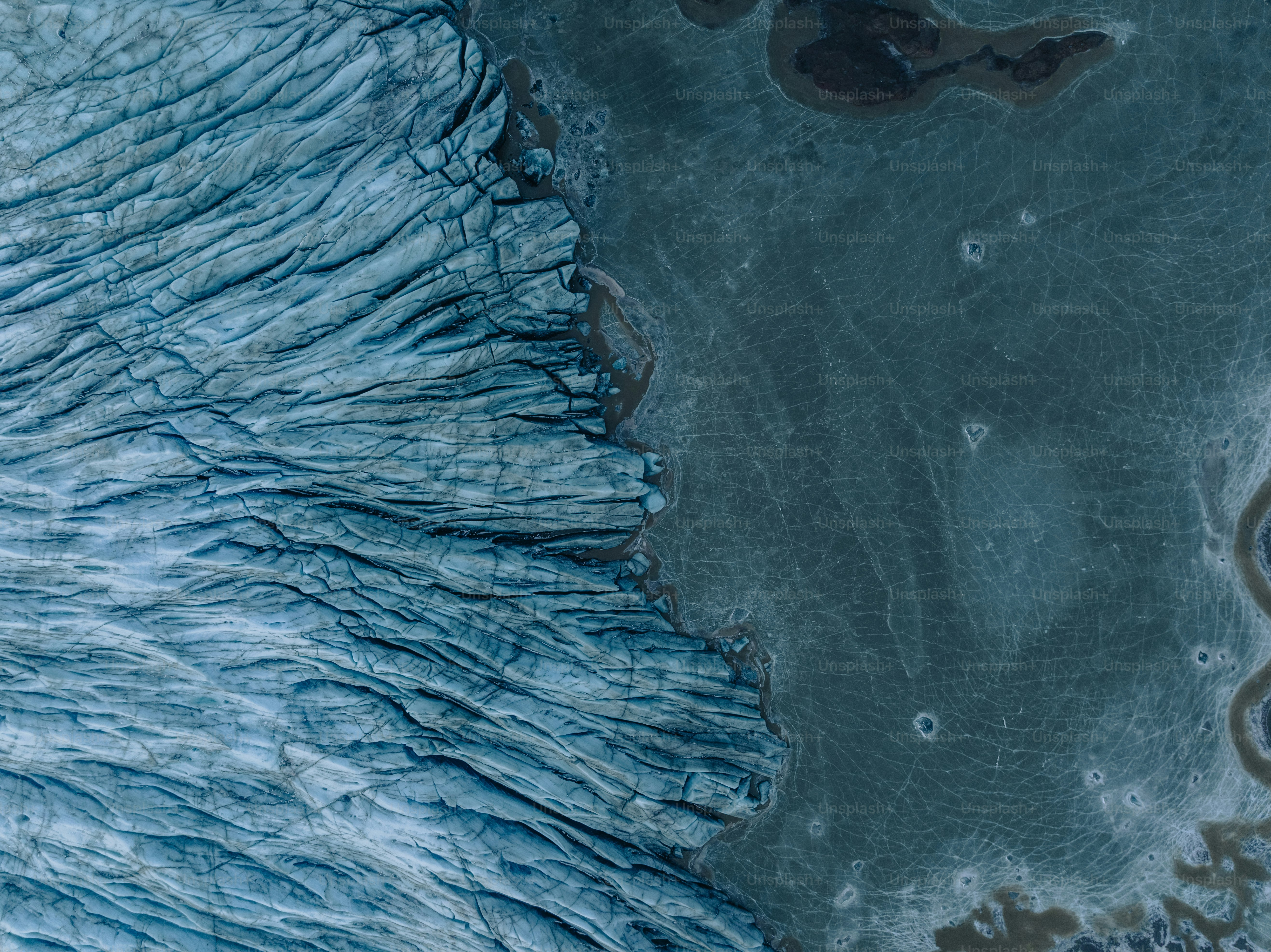 A group of ice chunks floating on top of a body of water photo ...