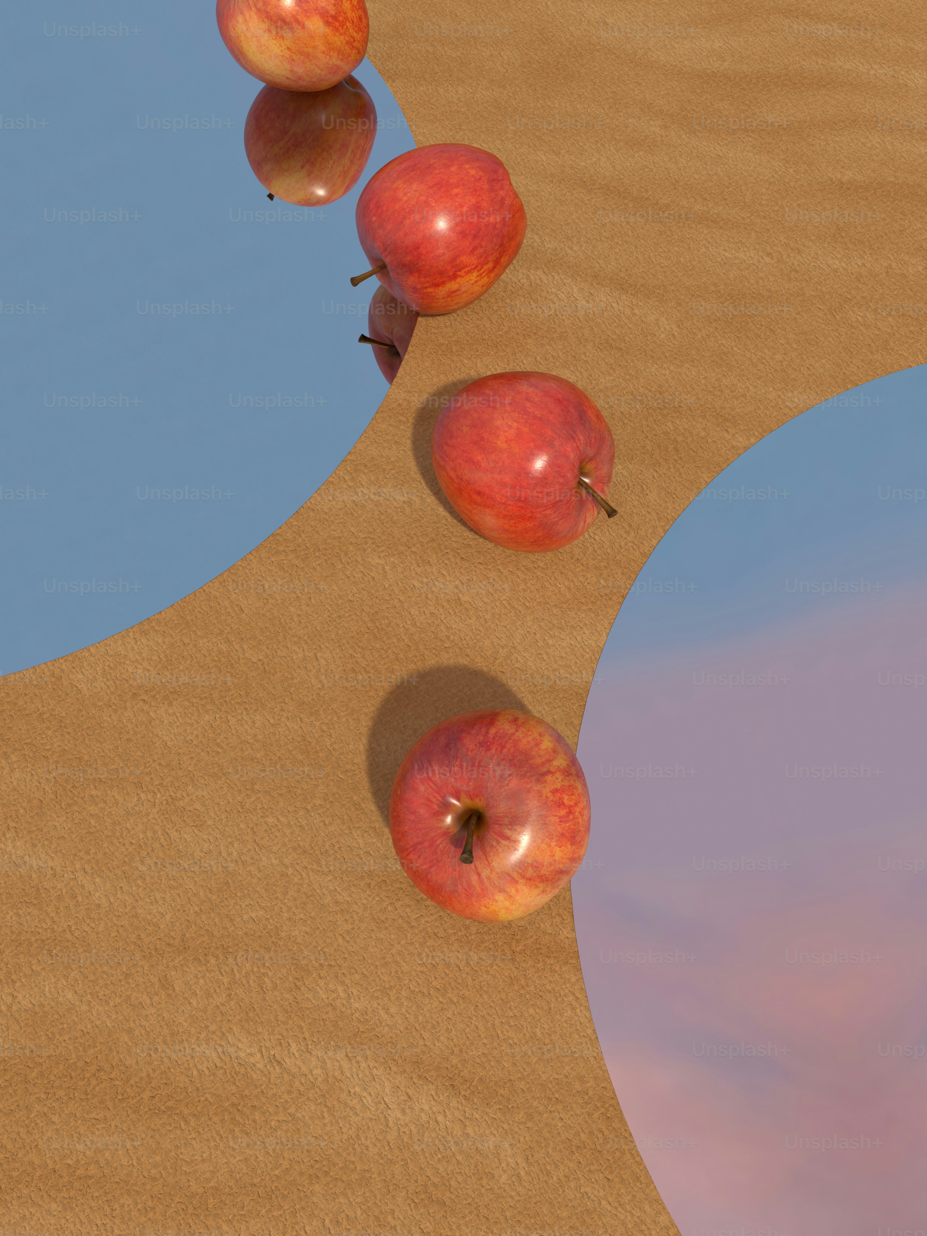 A group of apples sitting on top of a sandy beach photo – Apple ...