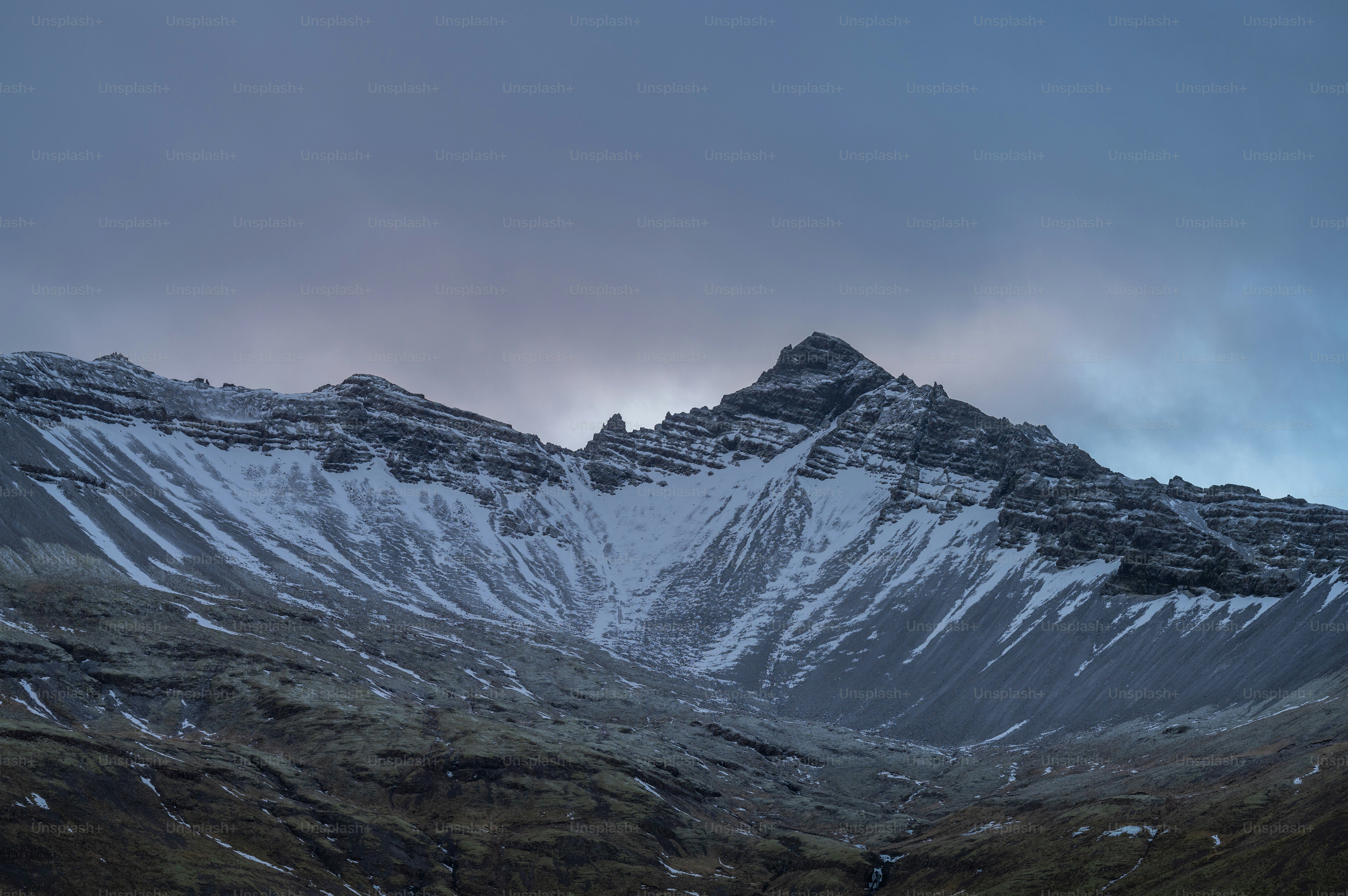 An aerial view of a mountain range with green and white rocks photo ...