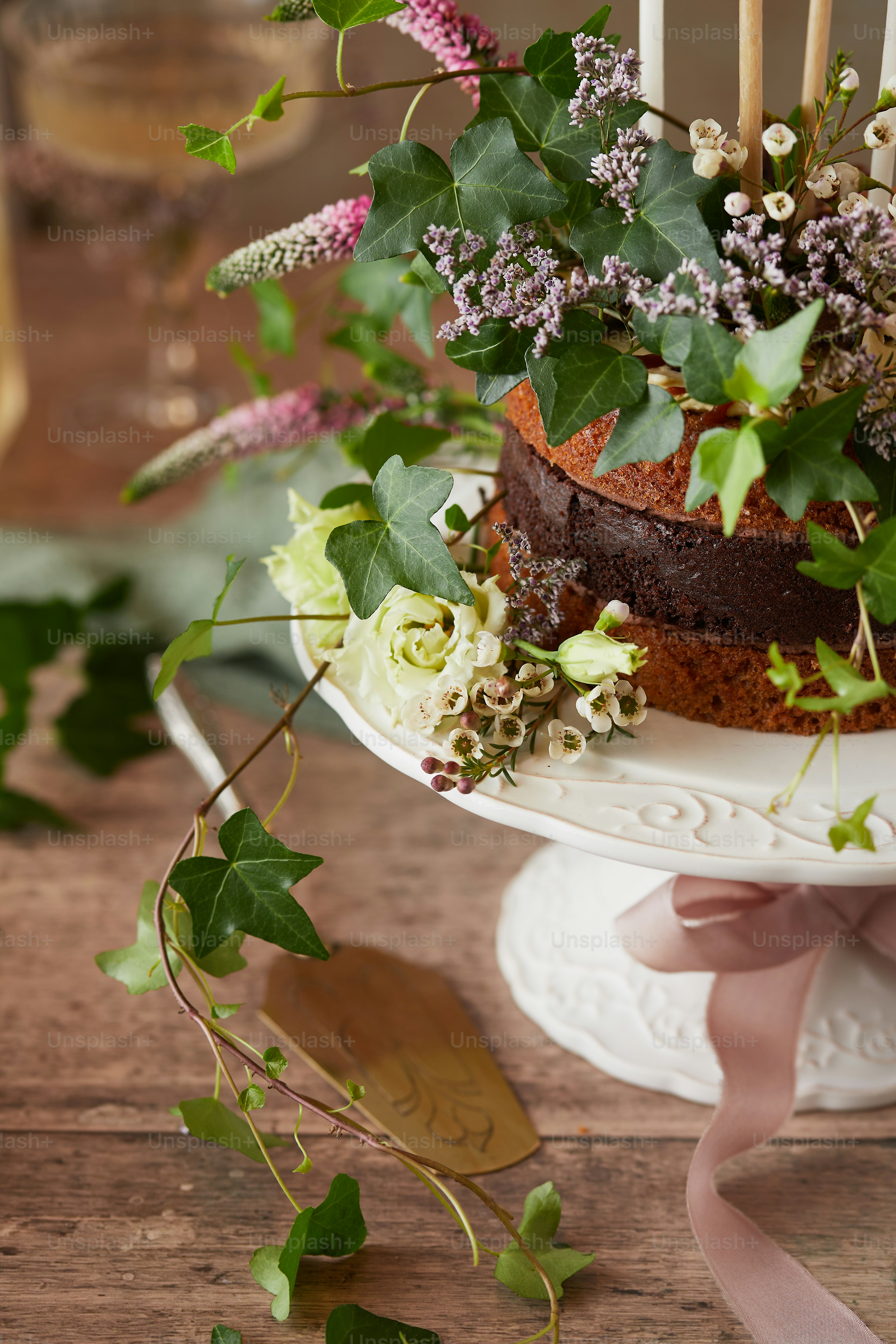 A cake sitting on top of a white cake plate photo – Wedding Image on ...
