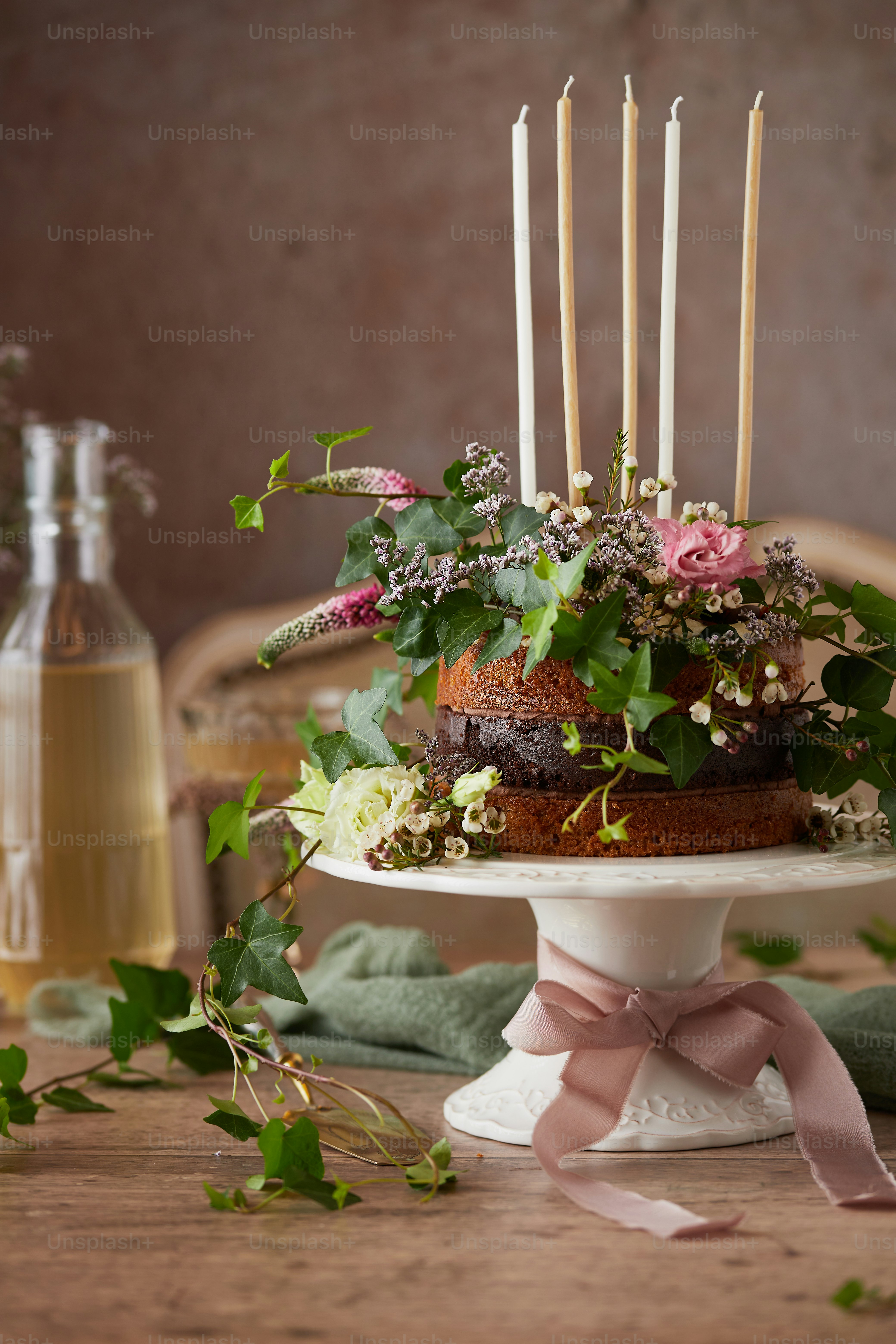 A cake sitting on top of a white cake plate photo – Wedding Image on ...