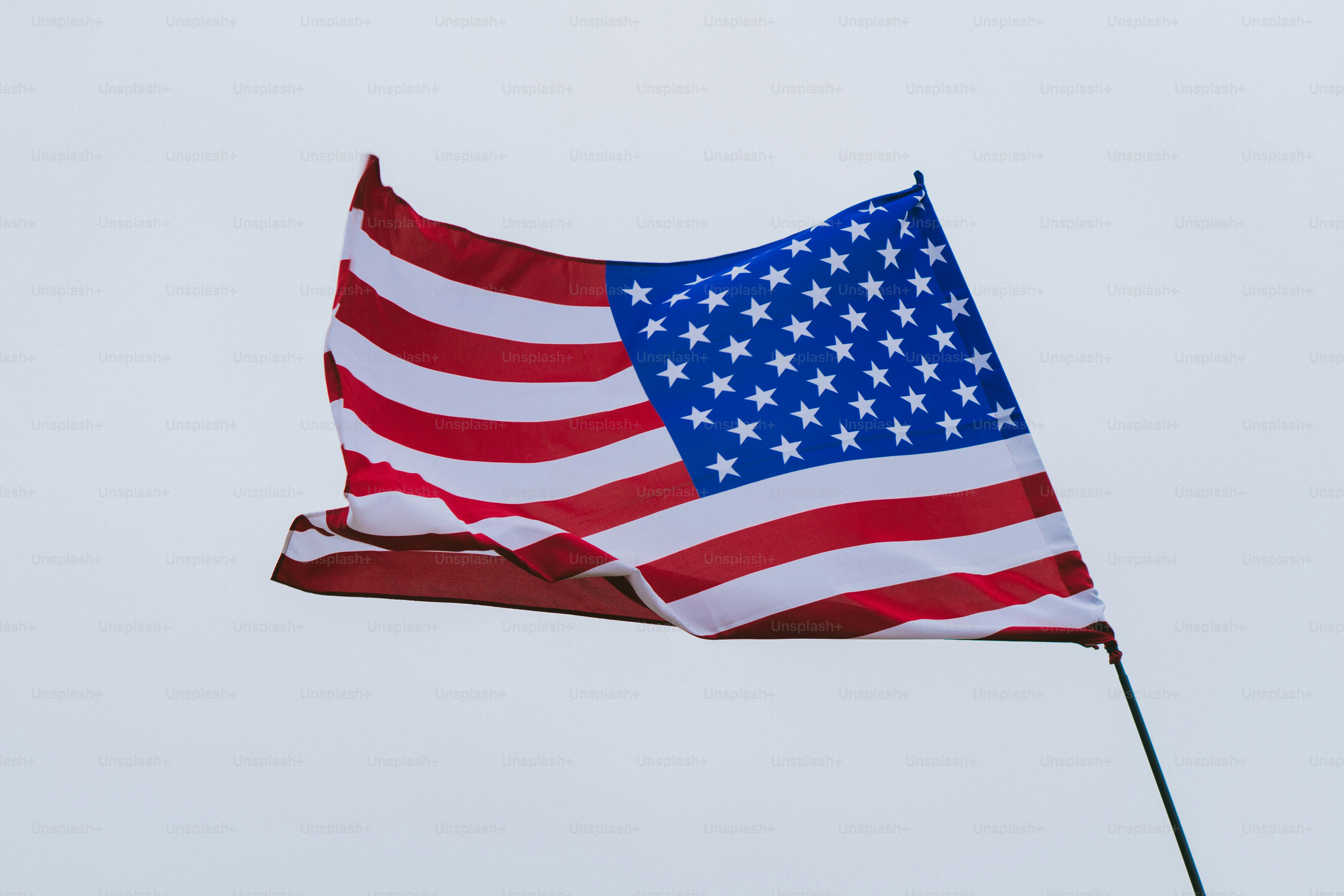 A large american flag flying in the sky photo – America Image on Unsplash