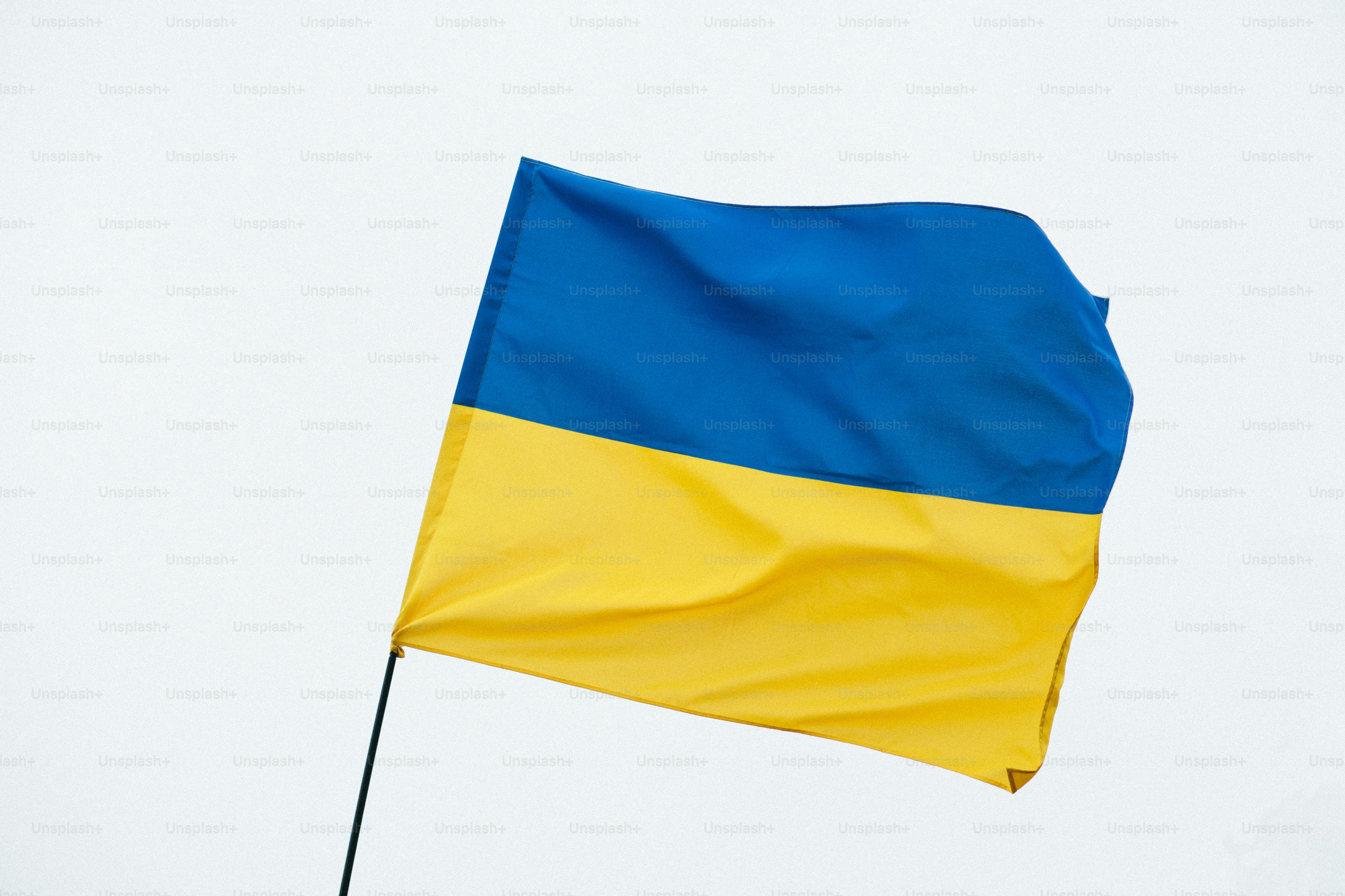 A blue and yellow flag flying in the sky photo – Flag Image on Unsplash