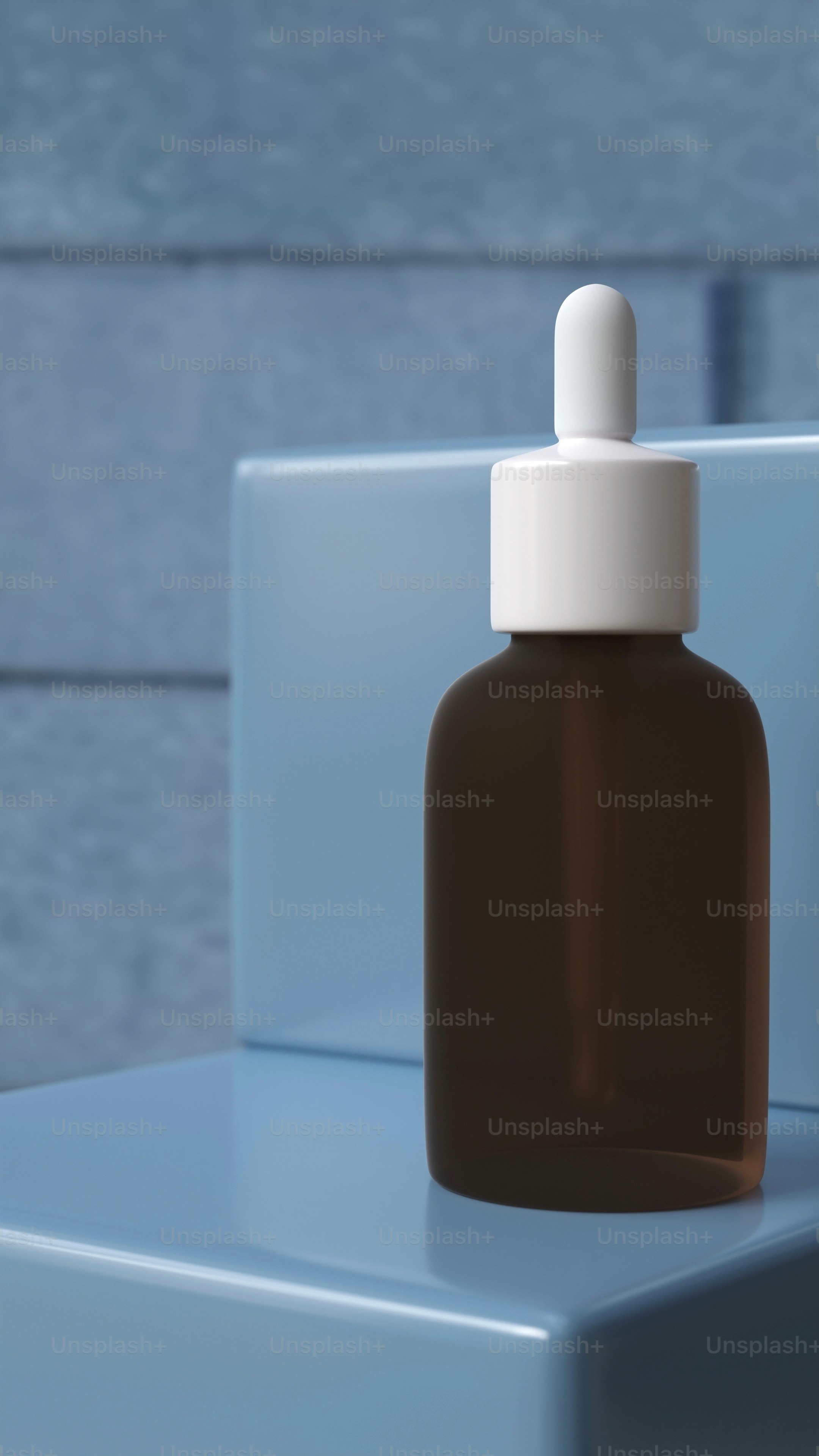 A bottle of brown liquid sitting on top of a blue chair photo ...