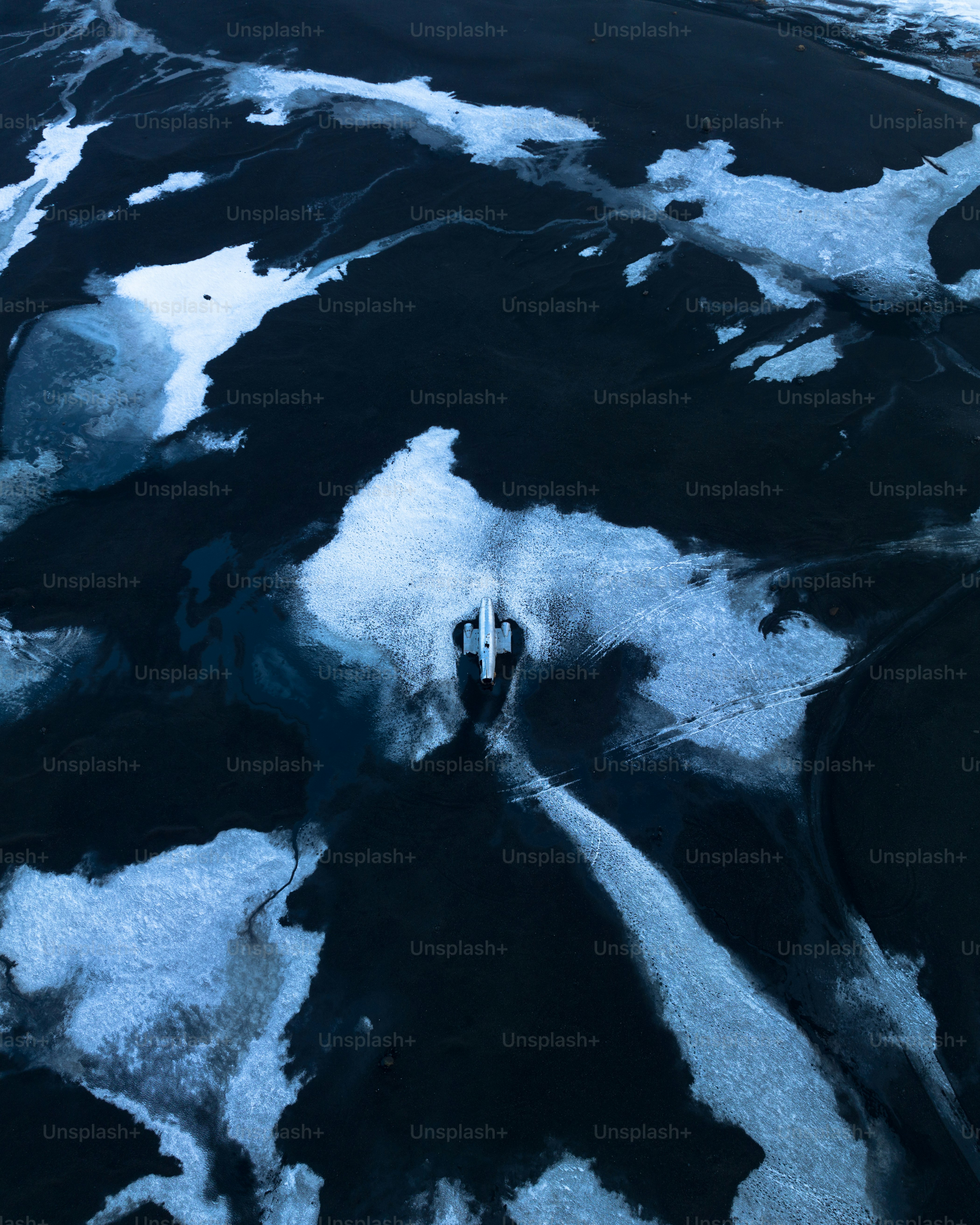 An aerial view of the ocean and land covered in ice photo – Dc3 Image ...