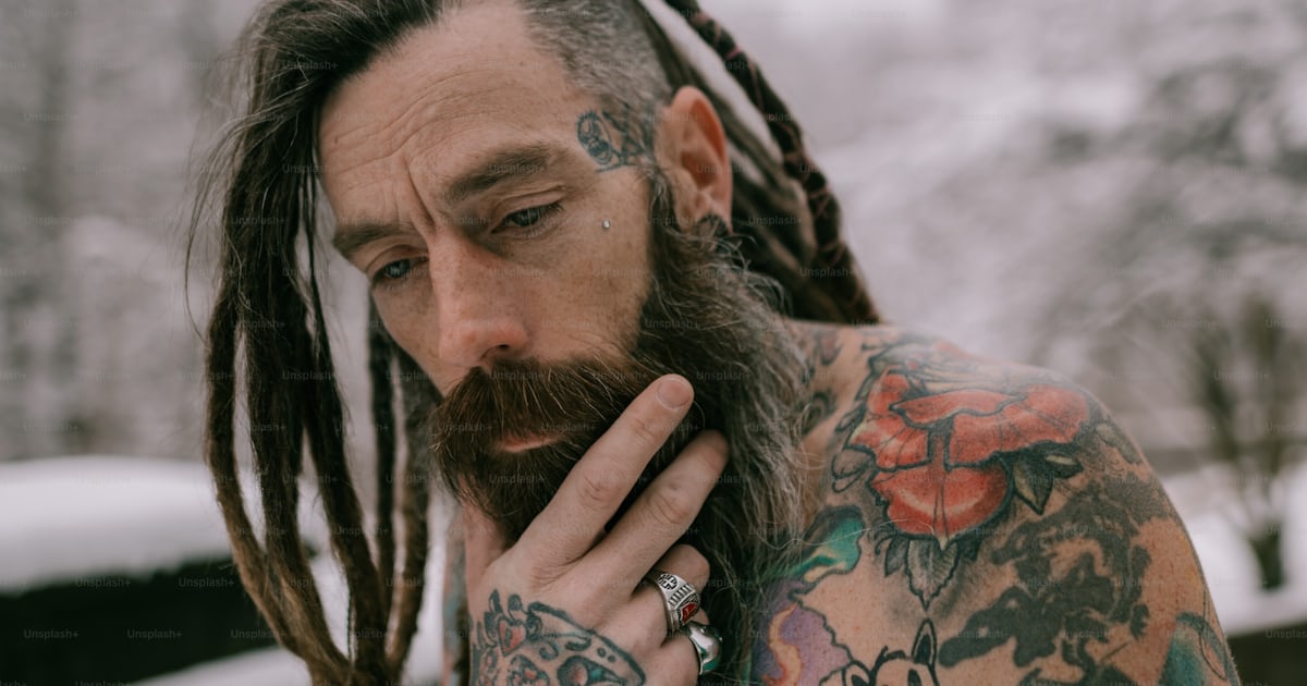 A Man With A Lot Of Tattoos On His Body Photo Man Hair Image On Unsplash