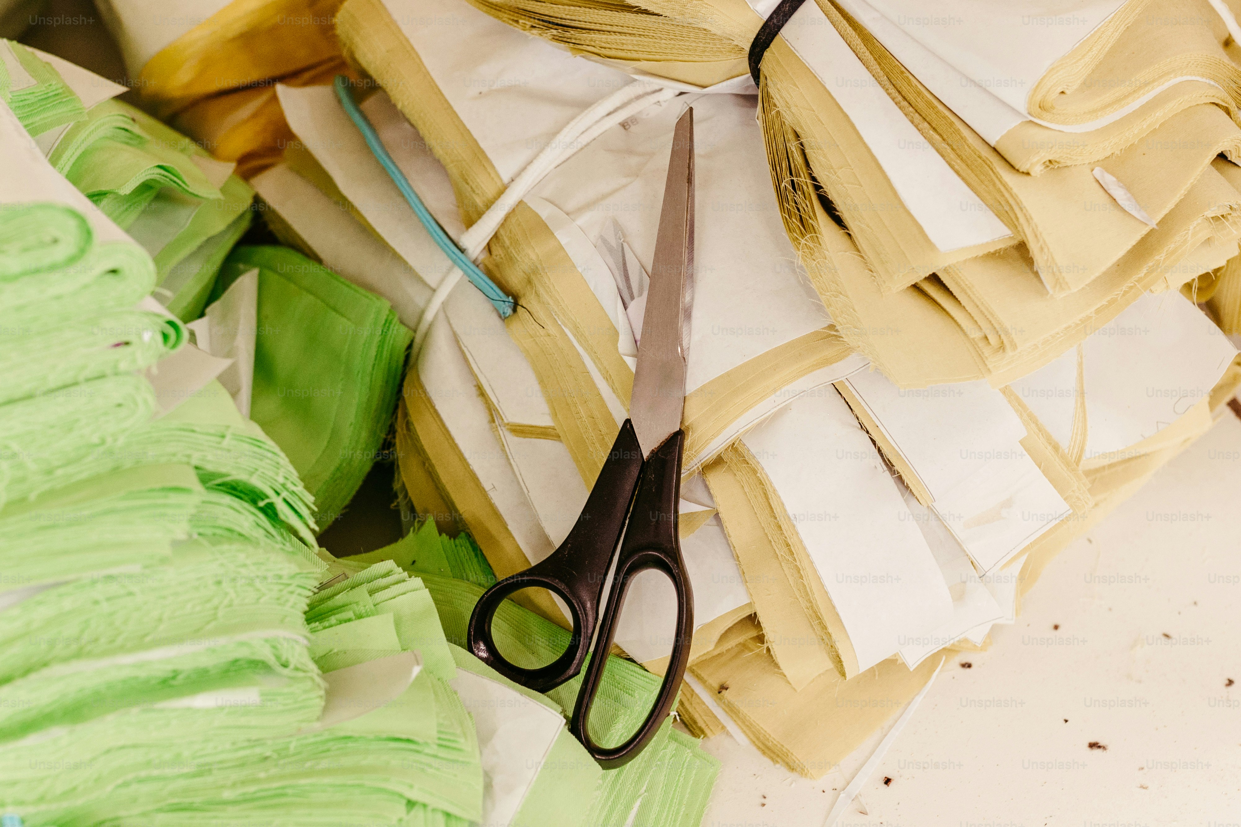 A pair of scissors sitting on top of a pile of books photo – Fashion ...