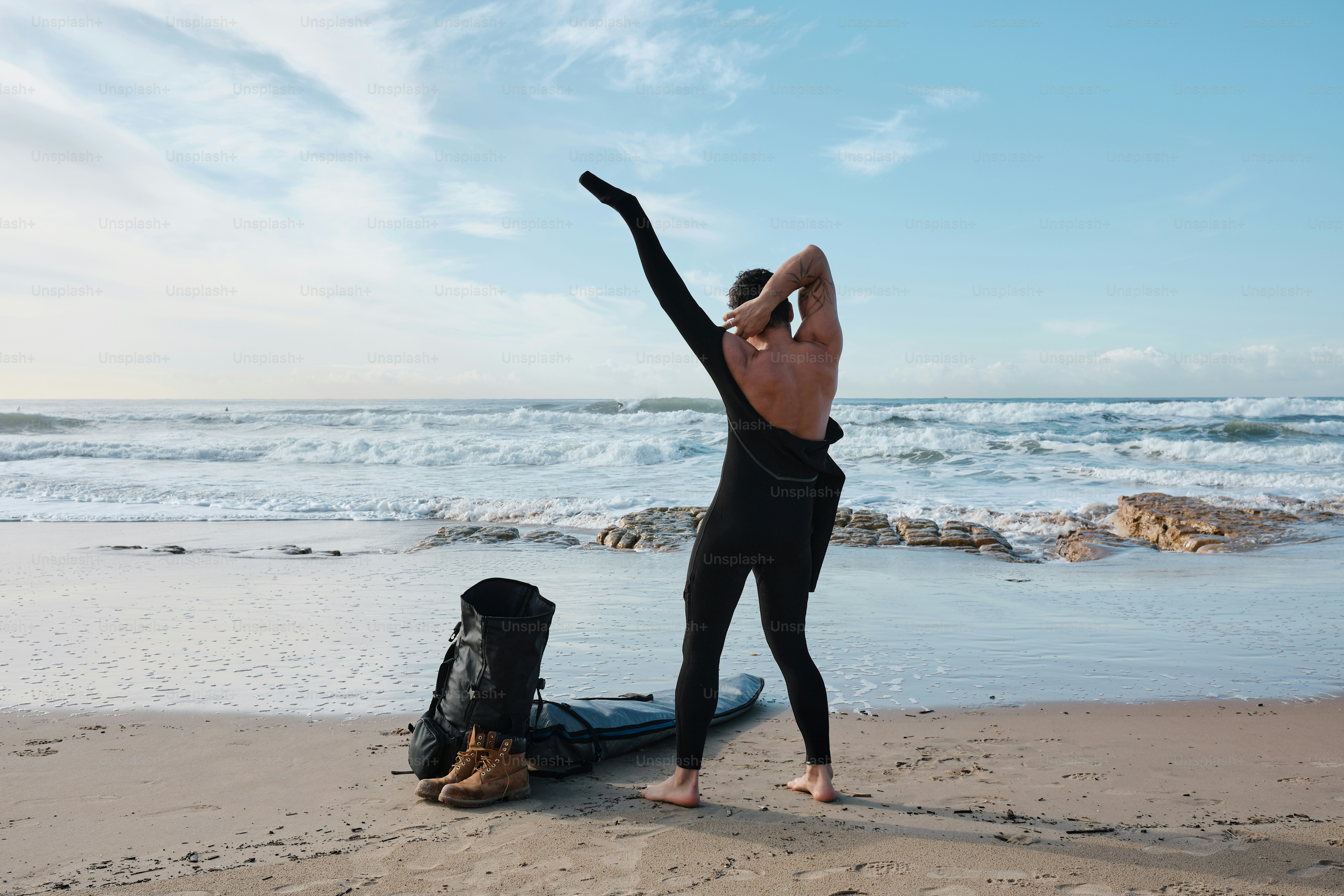 A man doing a handstand on a surfboard on the beach photo – Surfing ...