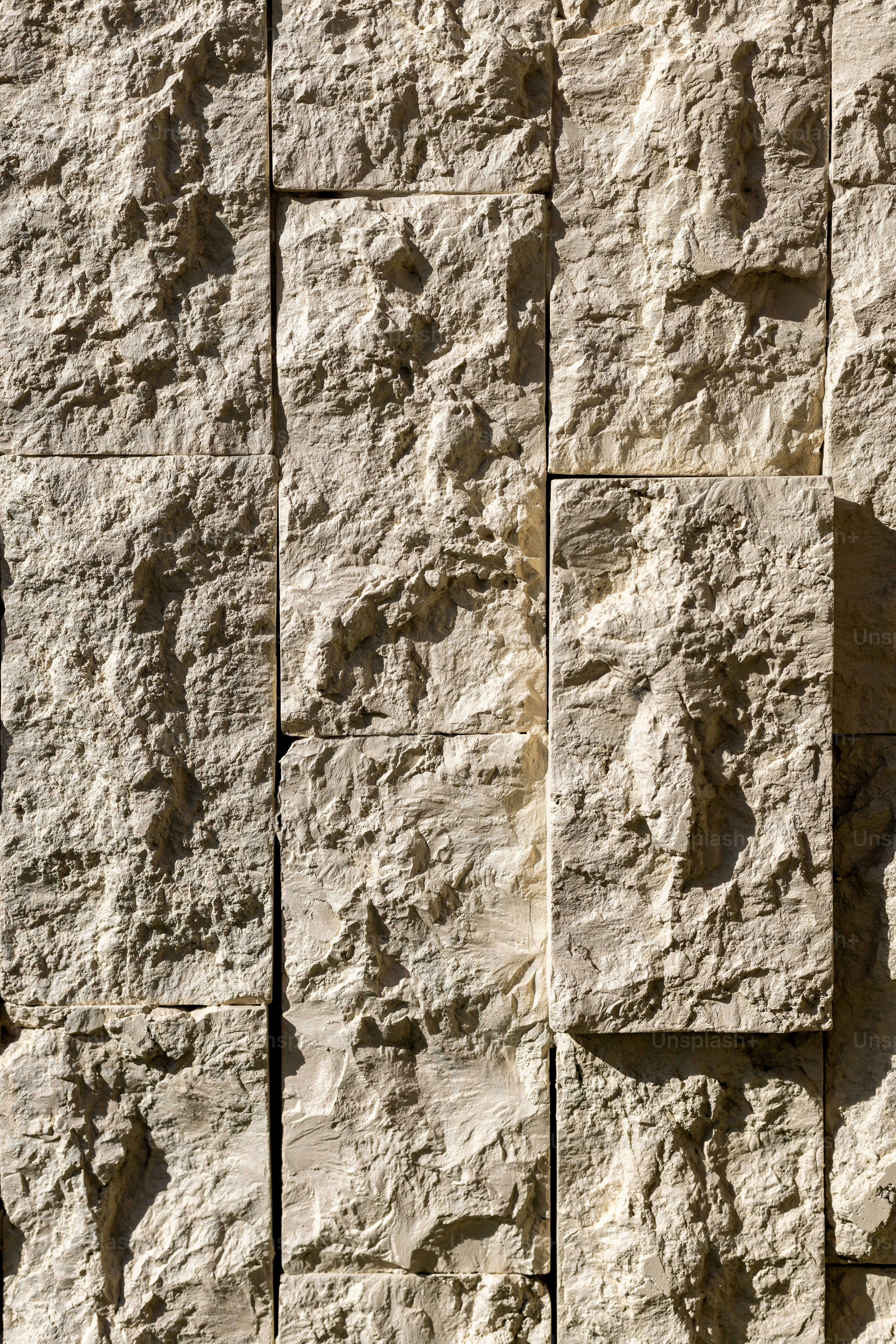 A close up of a stone wall with a clock on it photo – Brick texture ...