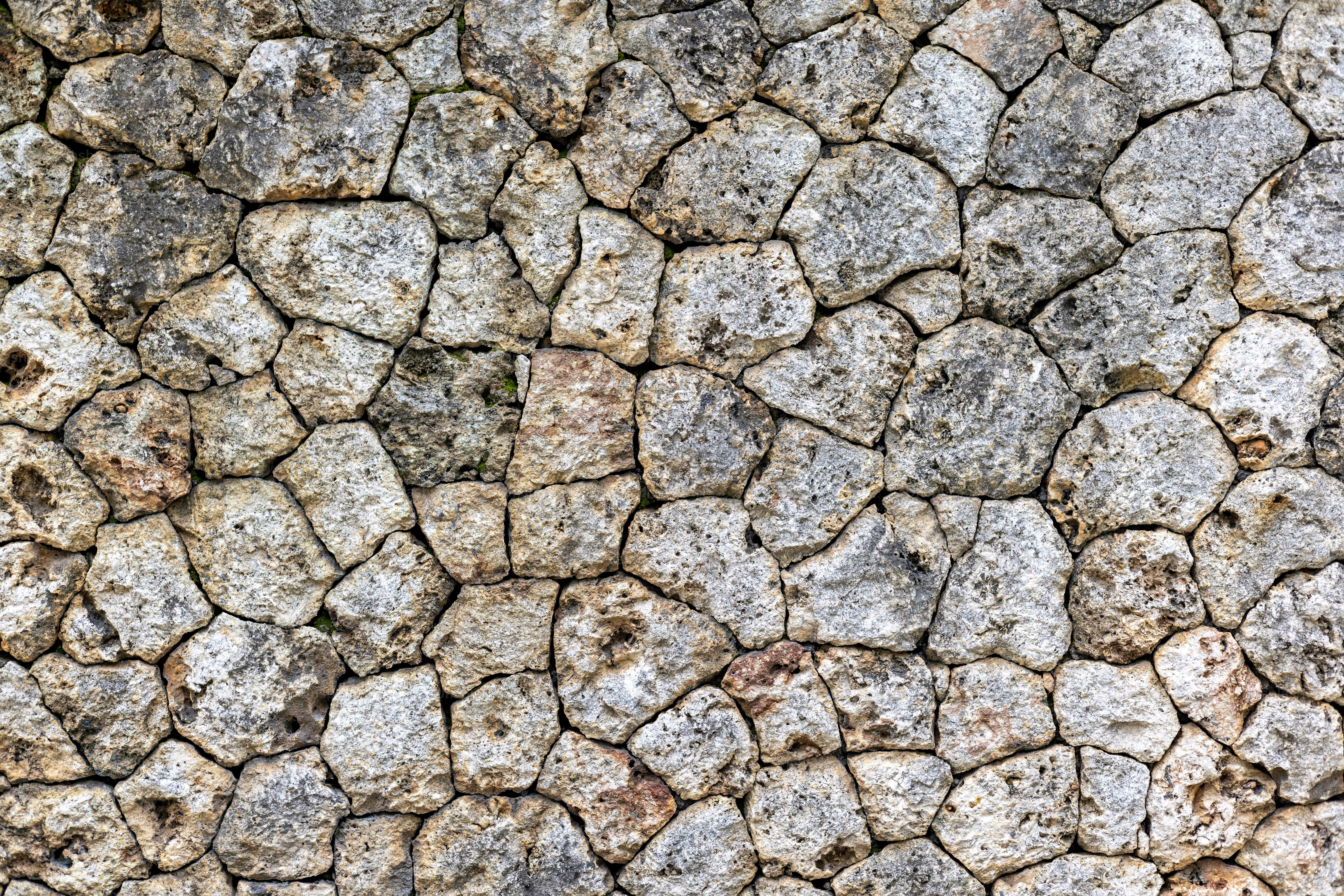 A close up of a stone wall with rocks photo – Natural stone Image on ...