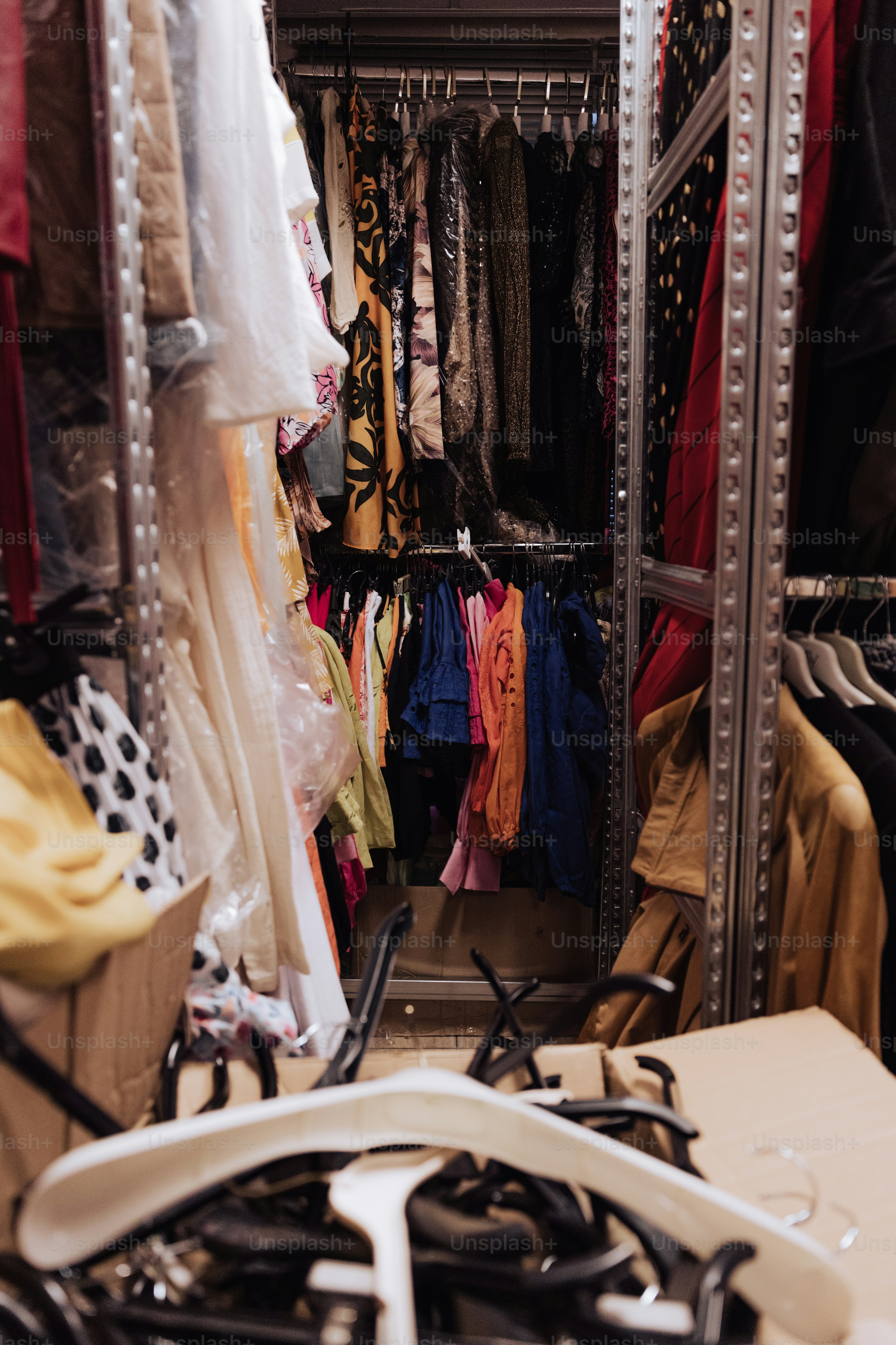 A closet filled with lots of clothes and ties photo – Clothes rails ...