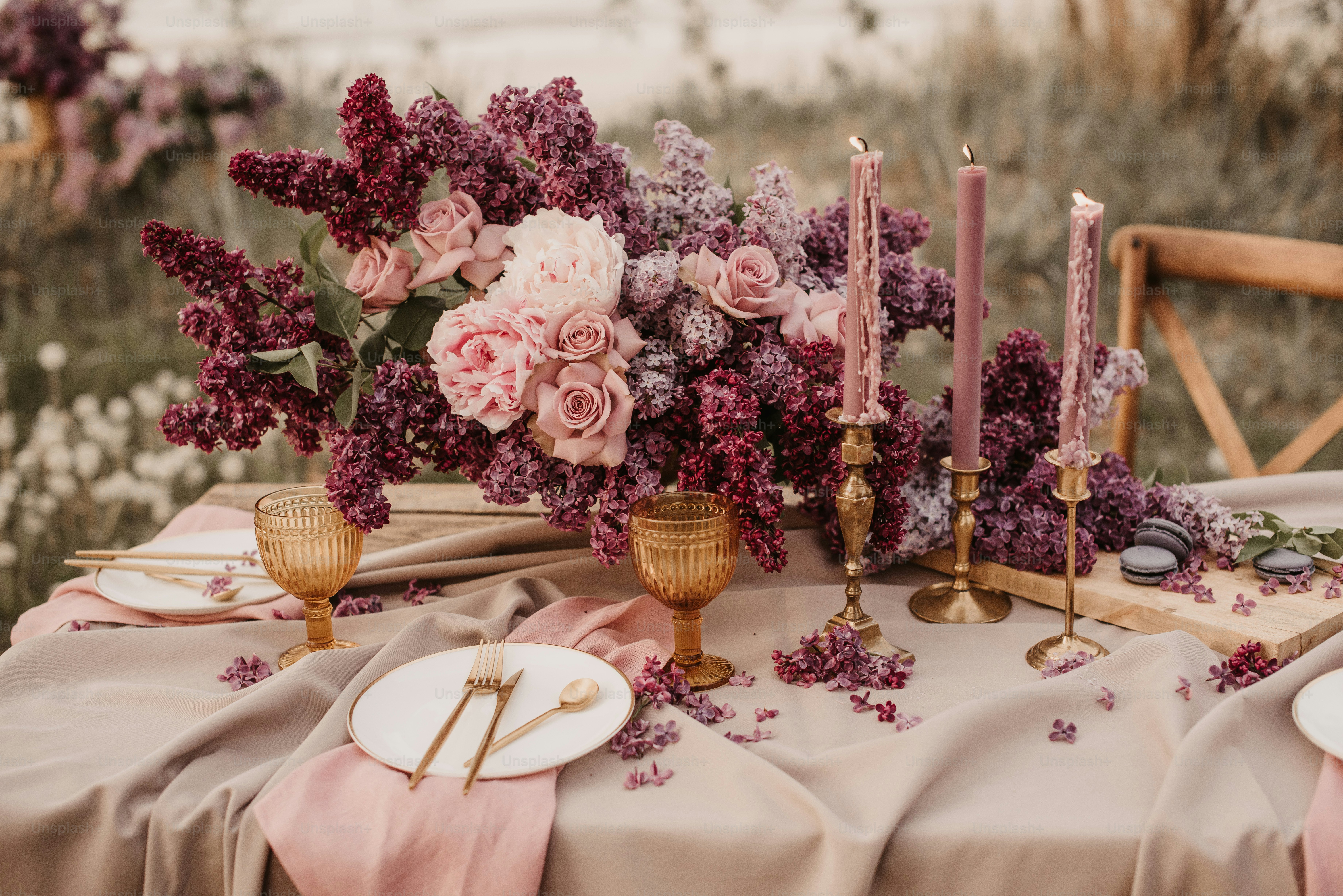 A table topped with pink flowers and candles photo – Wedding background ...
