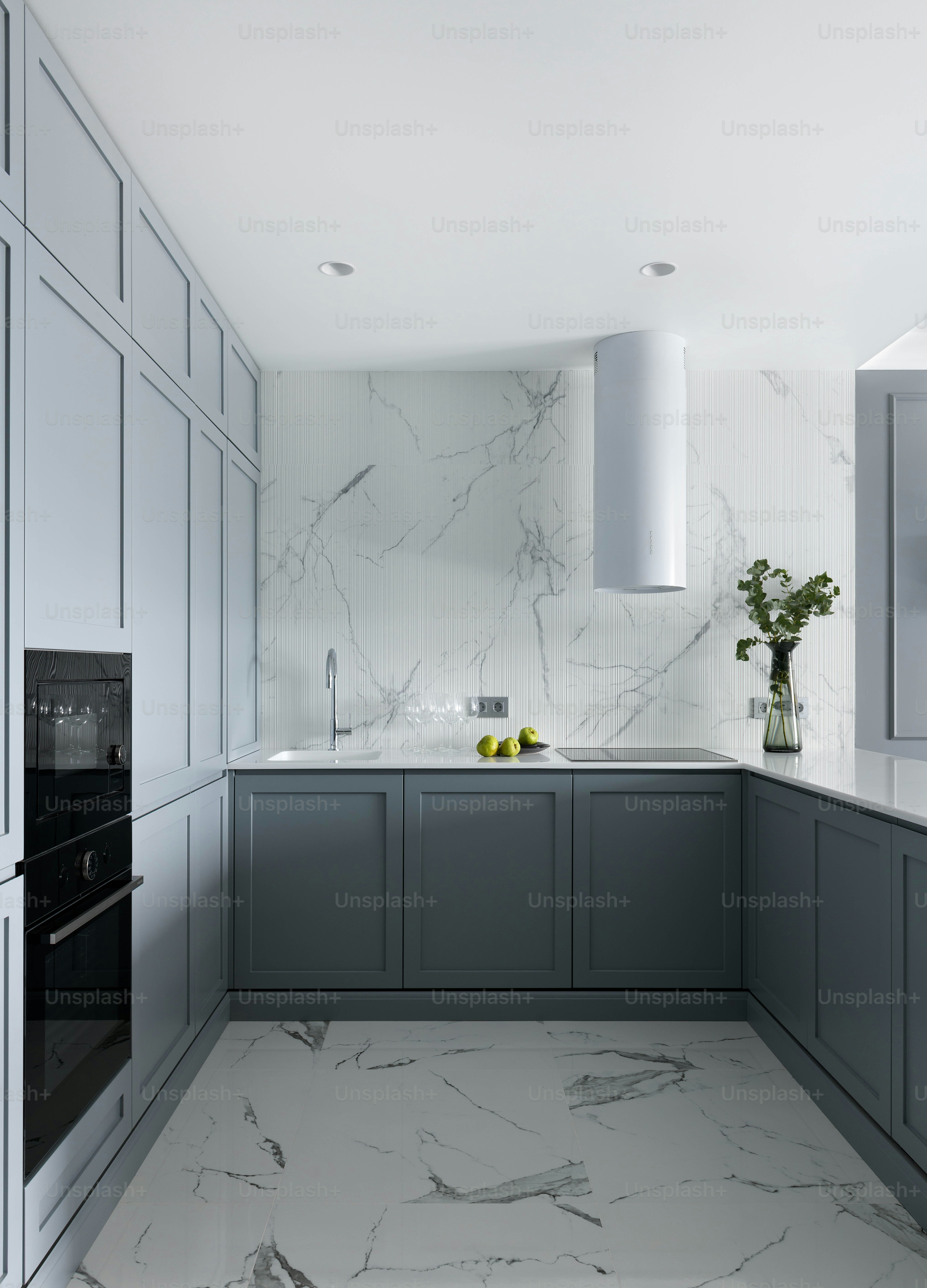 A kitchen with marble counter tops and gray cabinets photo – Interior ...