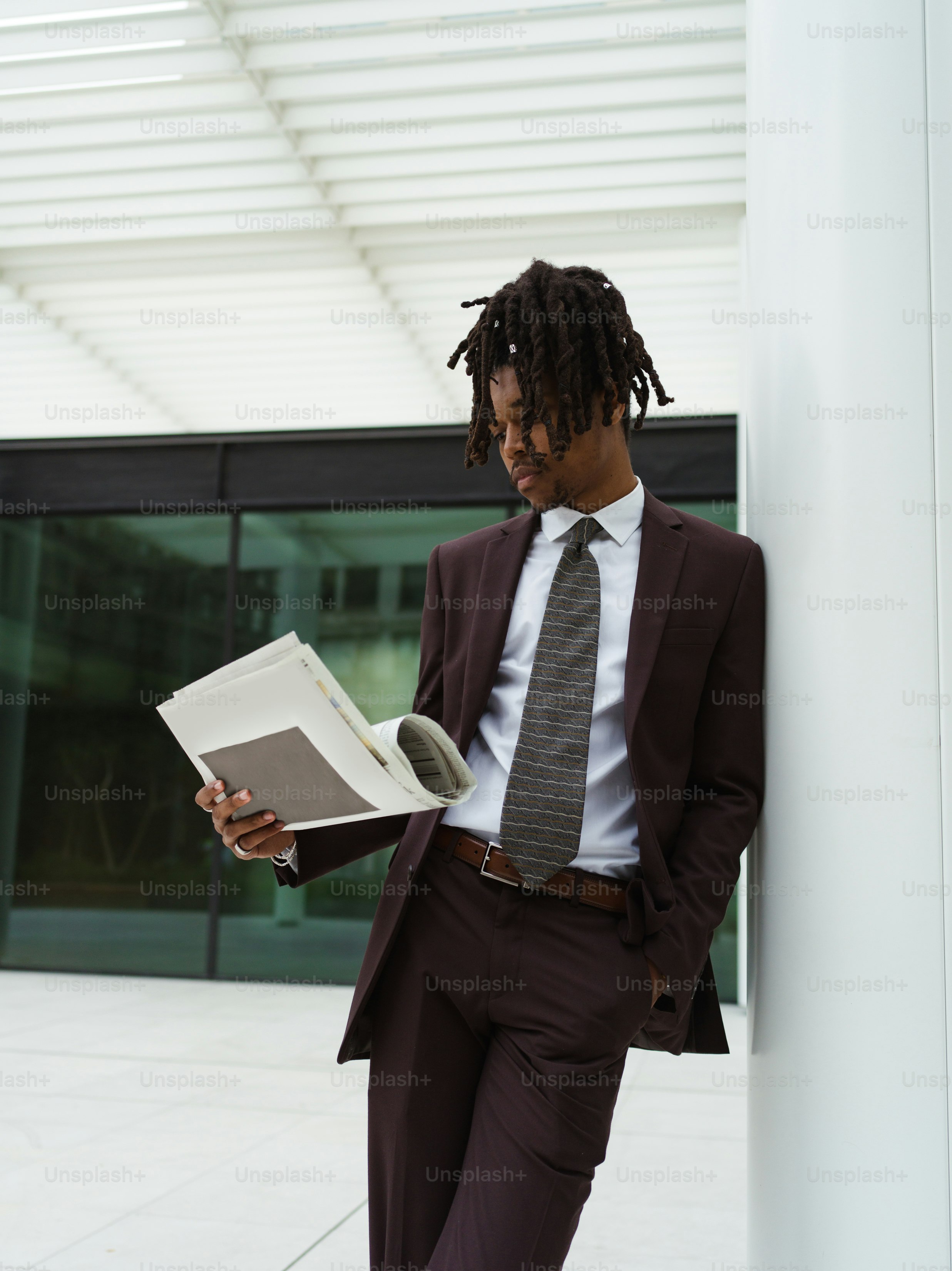 A man in a suit reading a book photo – Business Image on Unsplash