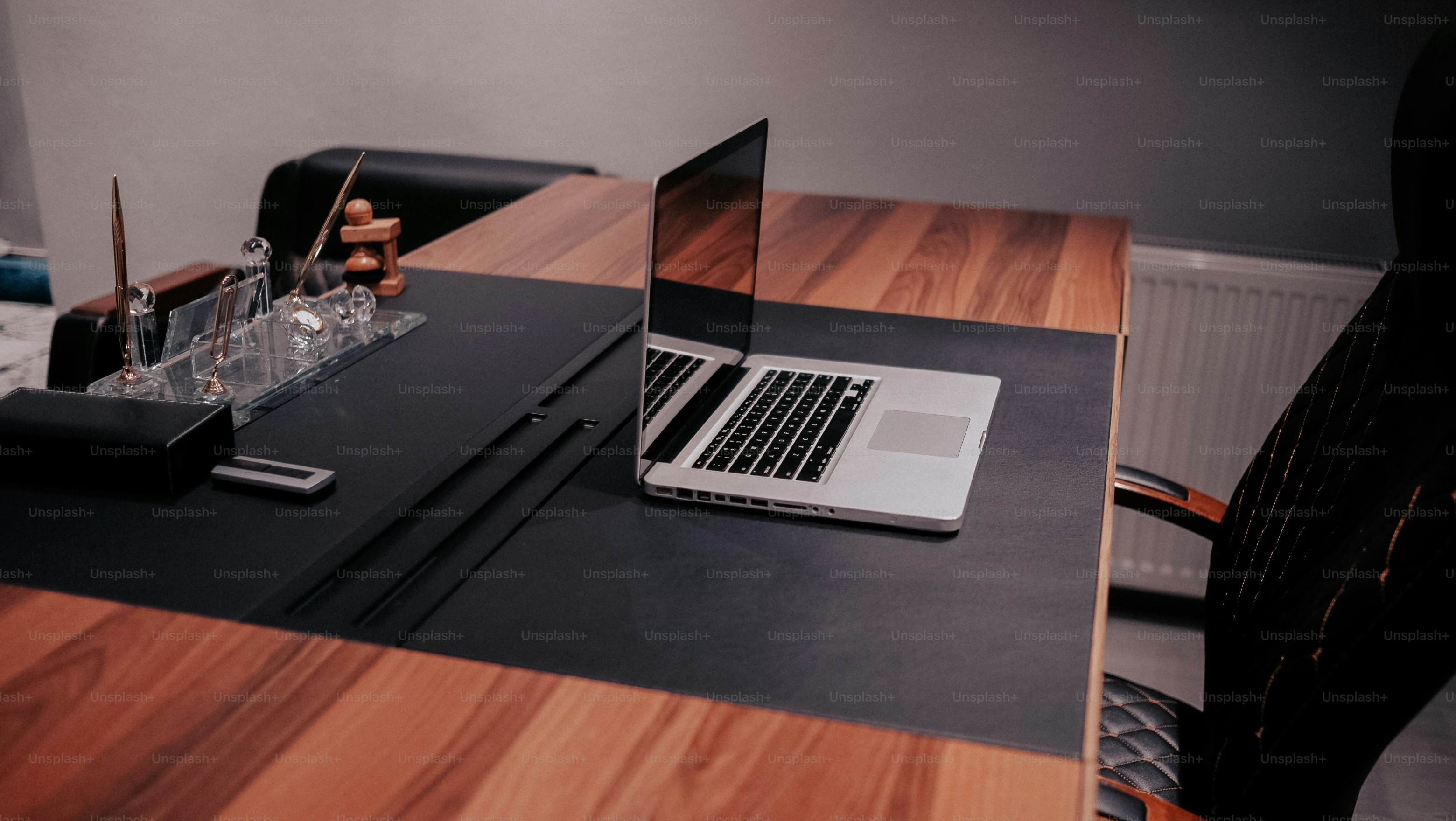 A wooden table with a laptop on top of it photo – Minimal office Image ...