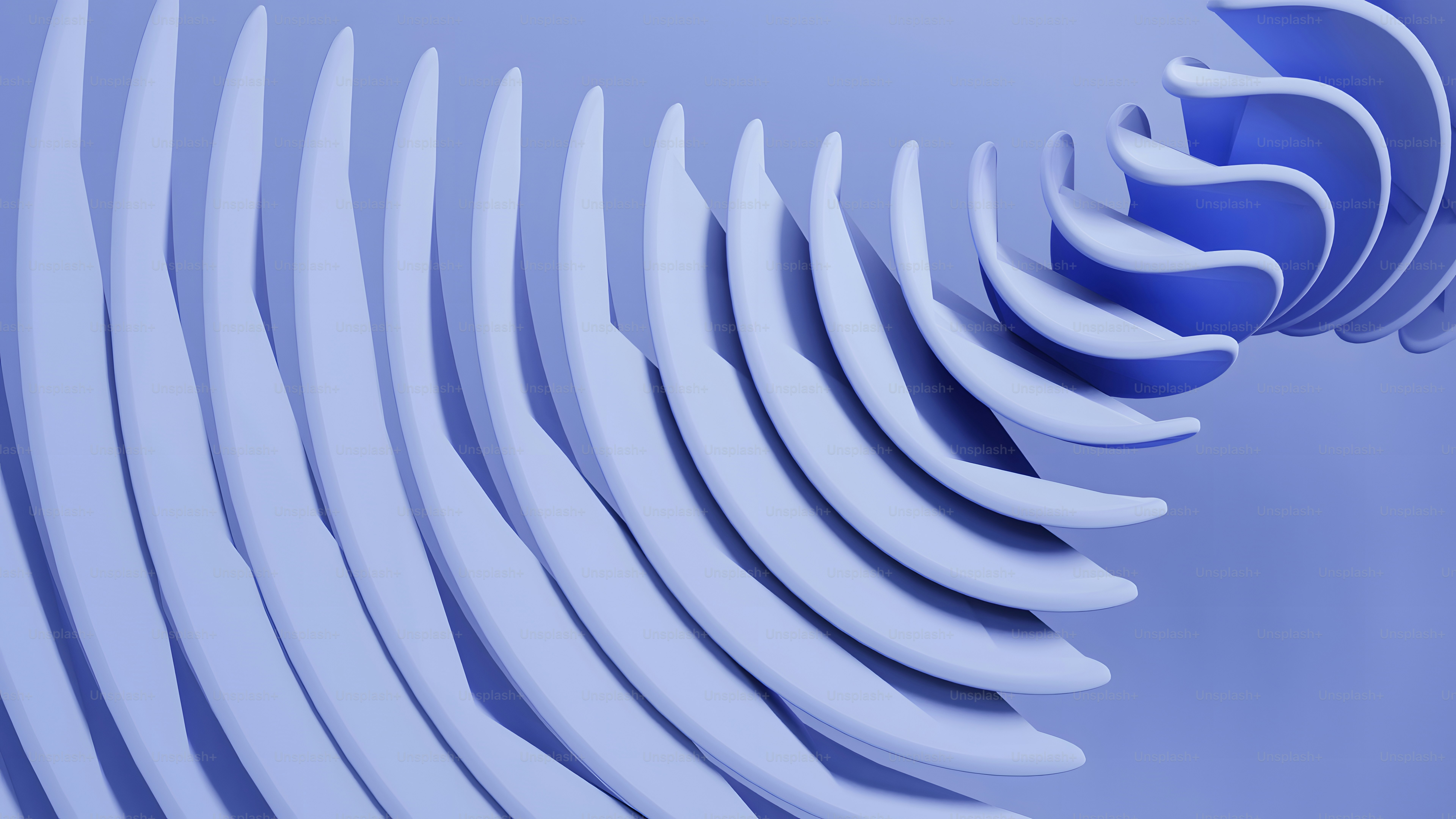 A close up of a curved object on a blue background photo – Blue Image ...