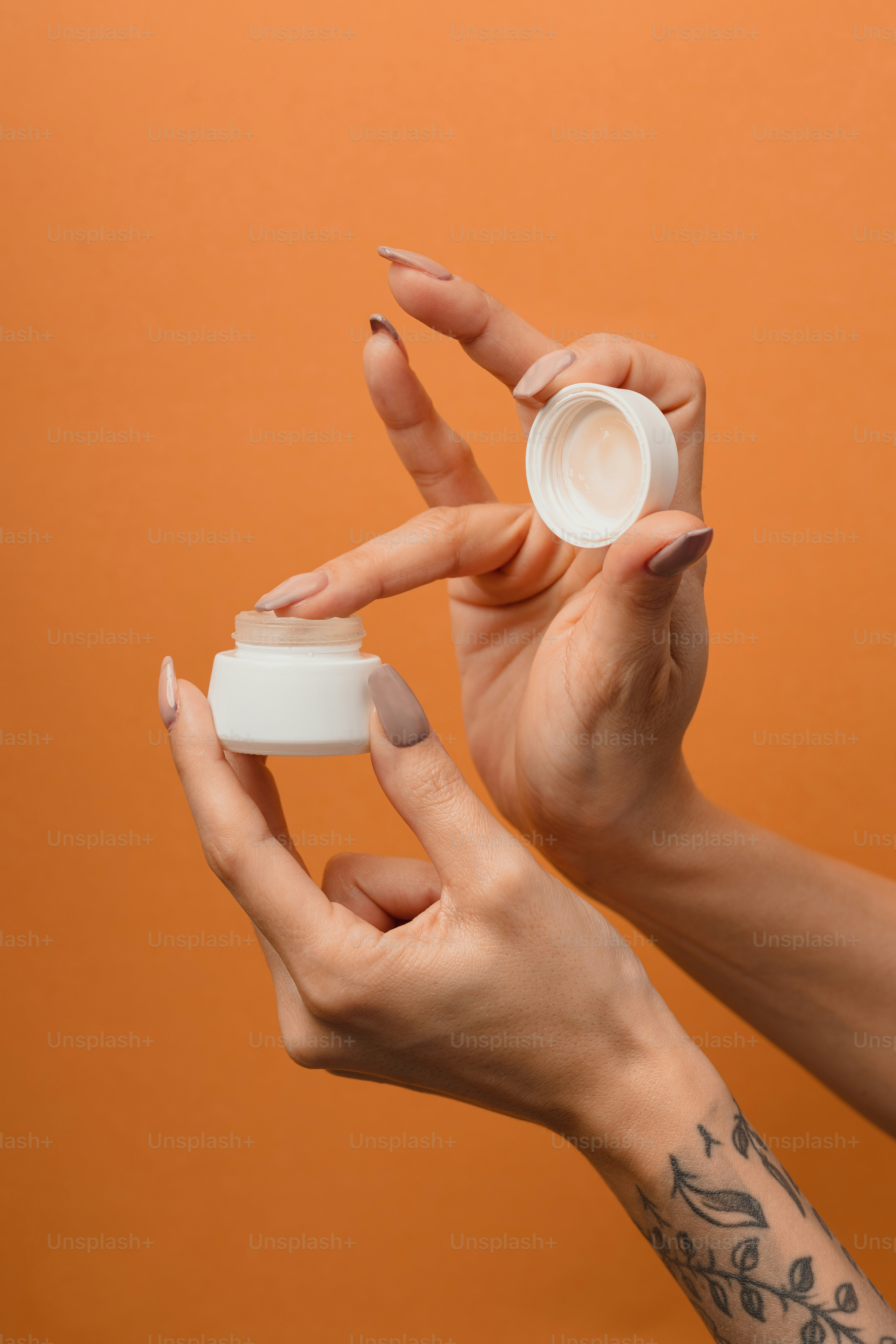 A woman holding a jar of cream in her hands photo – Cosmetics Image on ...
