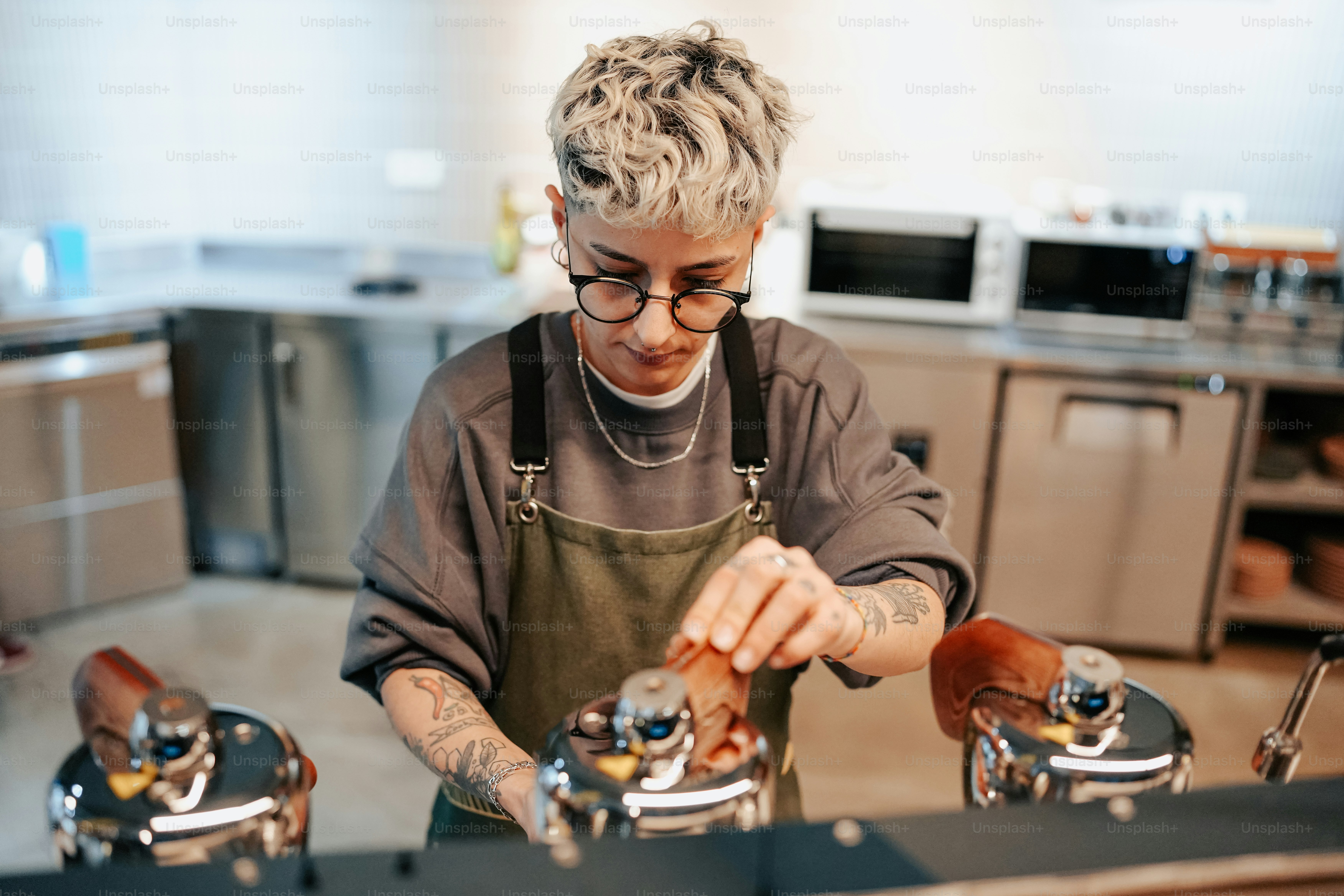 Foto Una mujer con delantal está llenando una taza de café – Trabajo ...