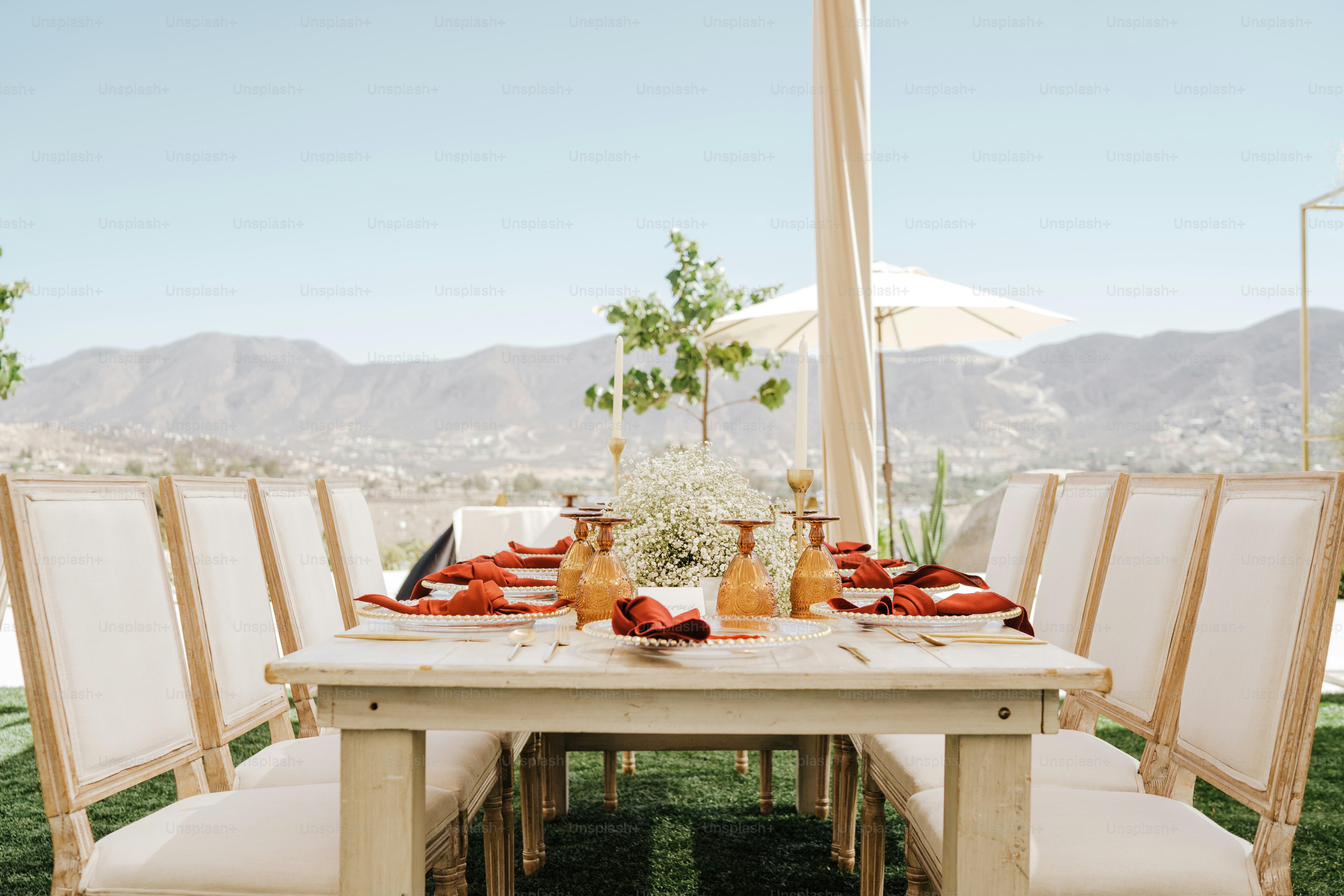 A table set up for a meal with a view of mountains photo – Valle de ...